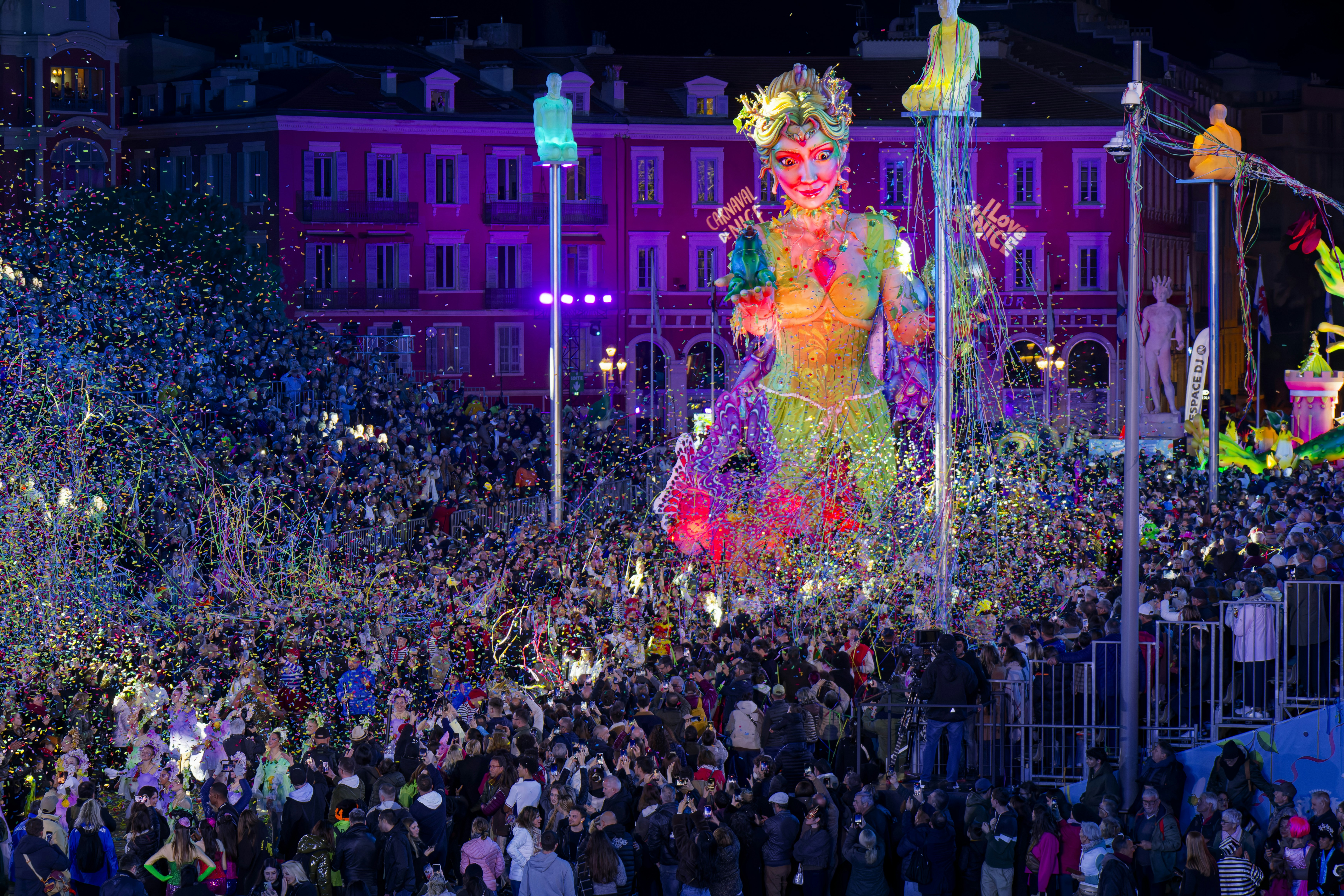 Neon Parade: A Giant Floating Performer Surrounded by a City Crowd