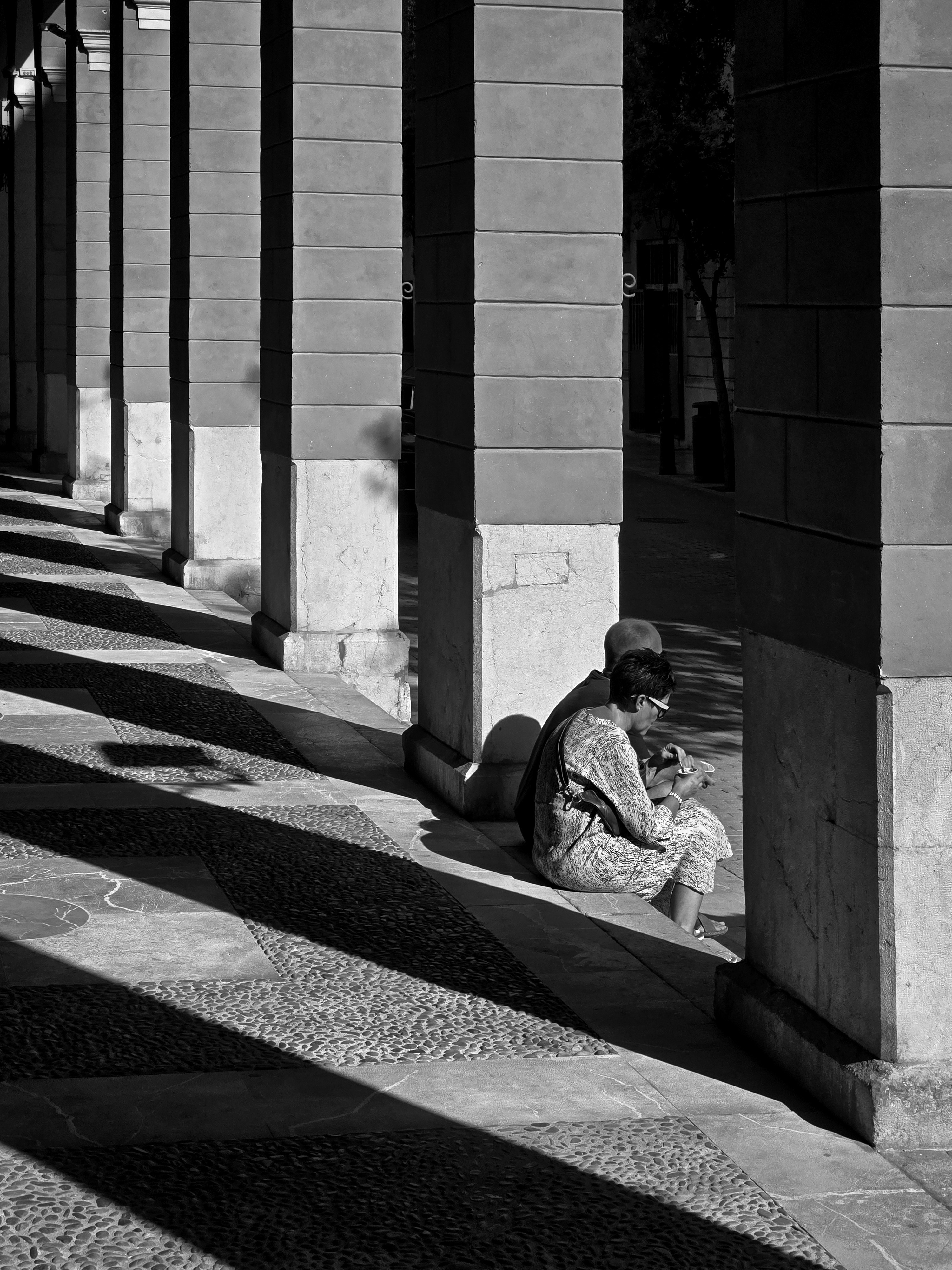Shadows and Solitude Under Colonnade Light