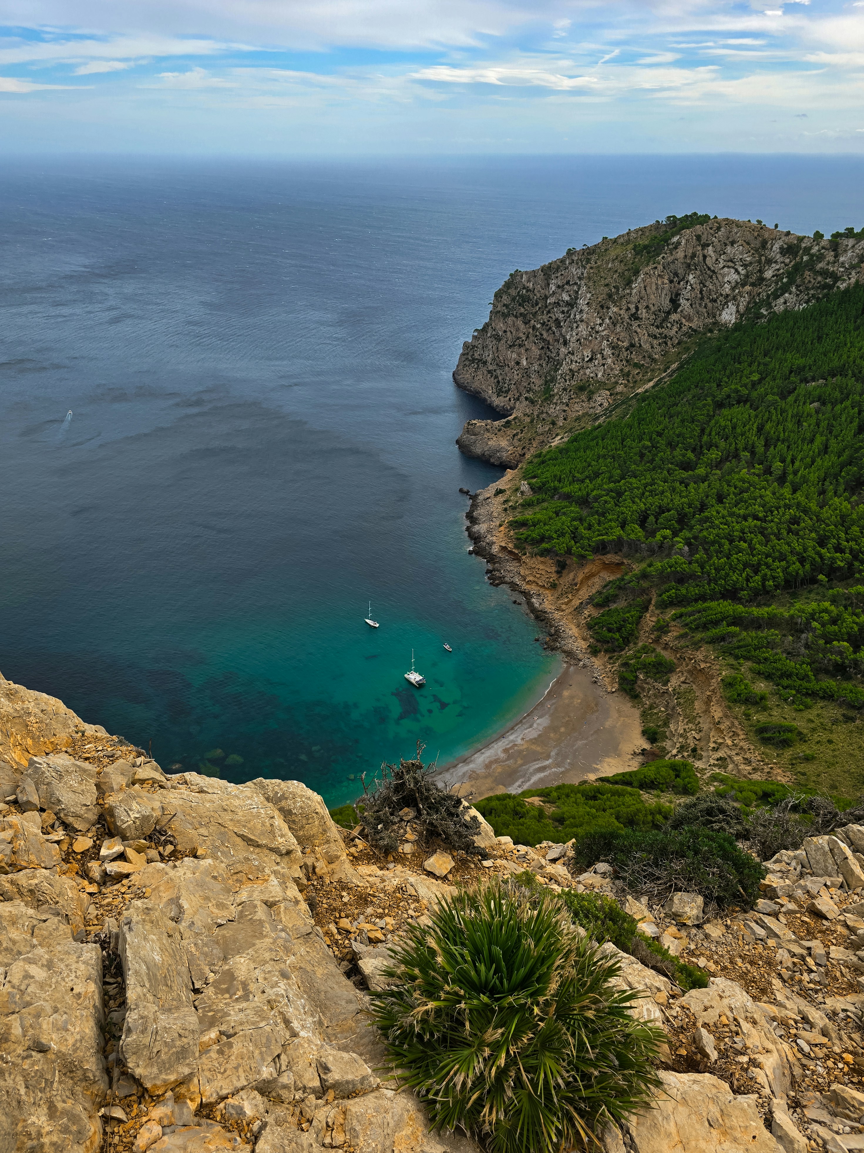 Cliffside Cove: Boats Hover Above Turquoise Waters