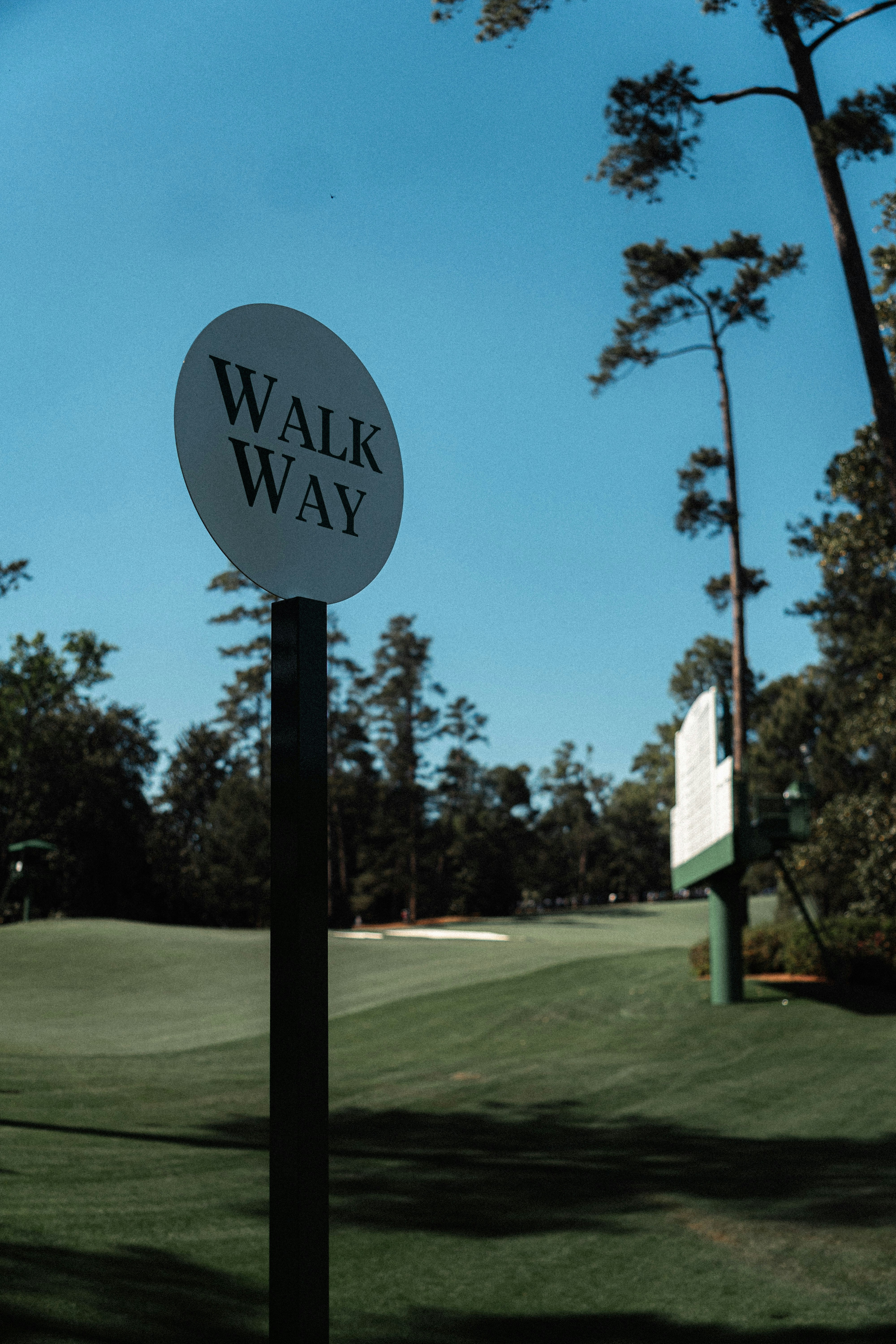 Circular Walk Sign Overlooking a Green Golf Course Path