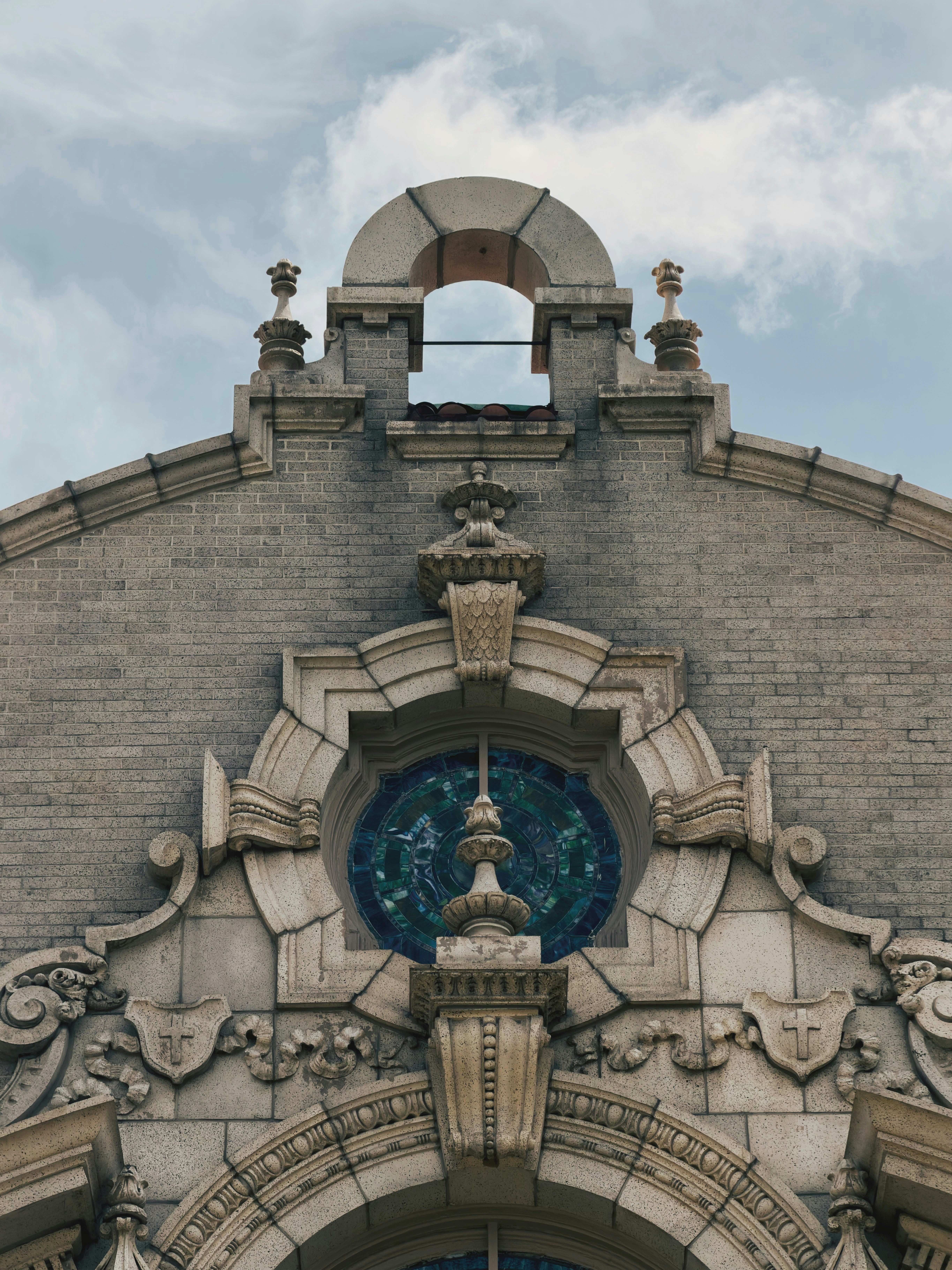 Arched Clockwork Rosette: A Historic Facade Crowned by Stone Ornament