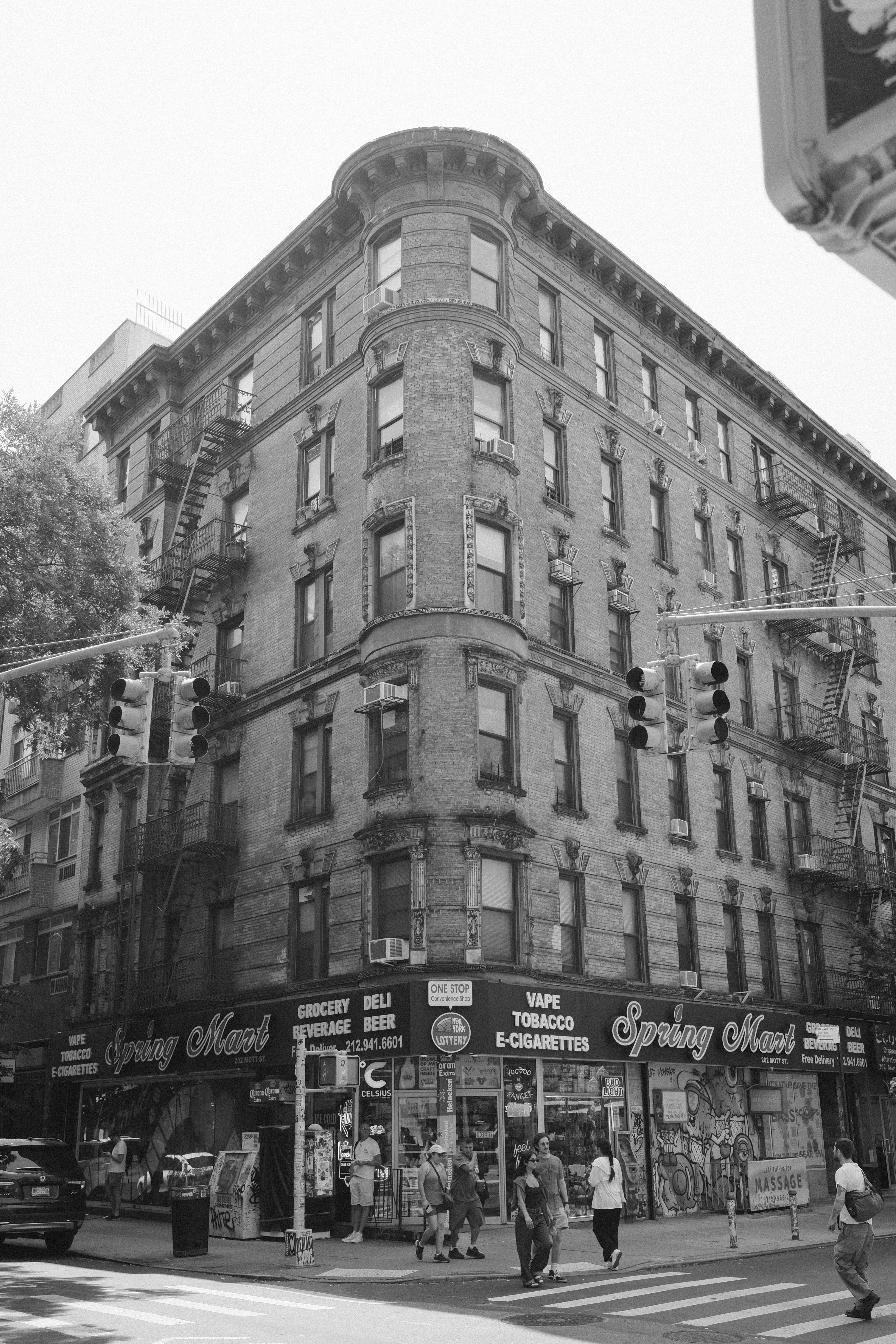 Cornerwise Commerce: A Historic Storefront Framed by a Brick Multifamily Building