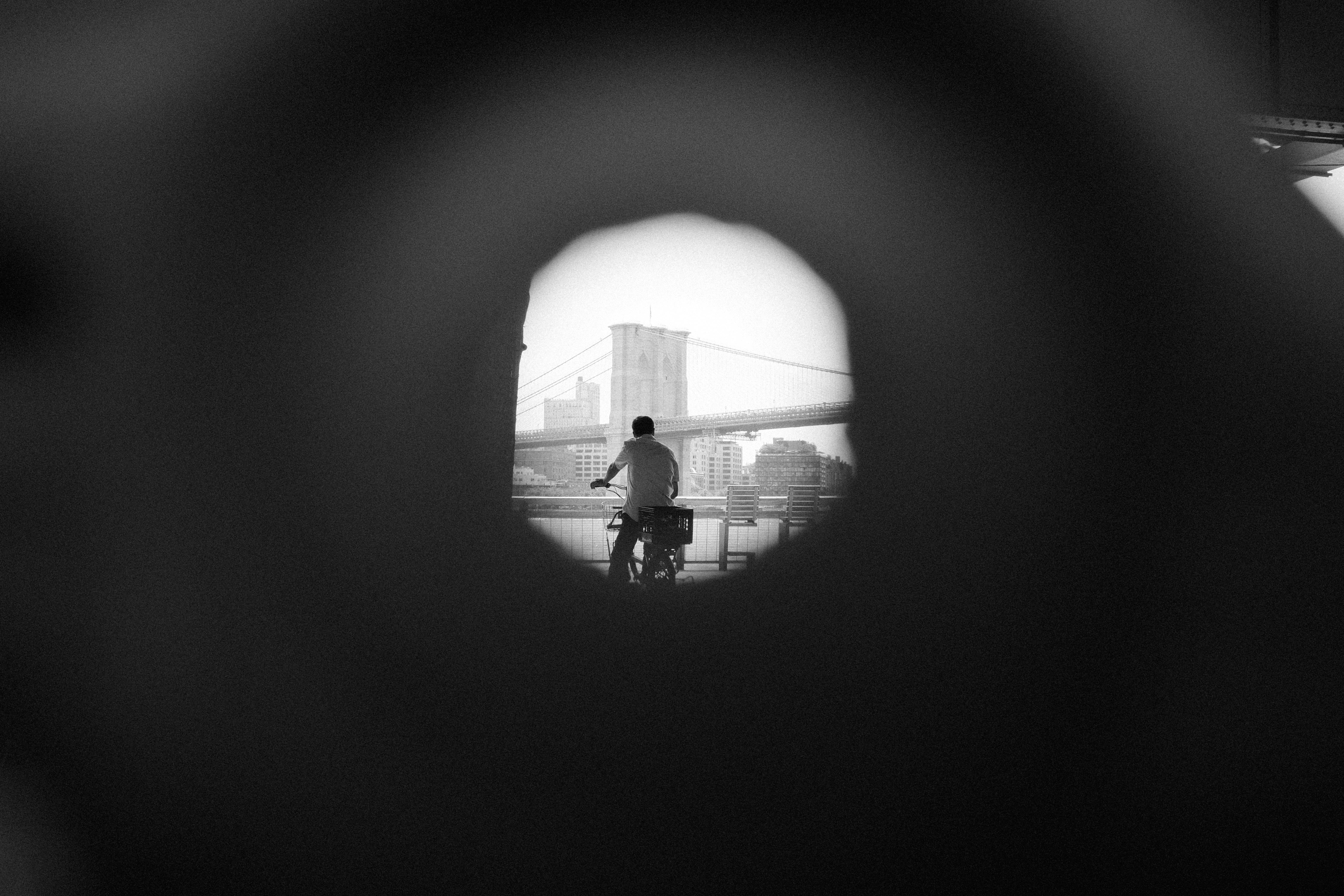 Through the Ring: Cyclist on a Quiet City Bridge