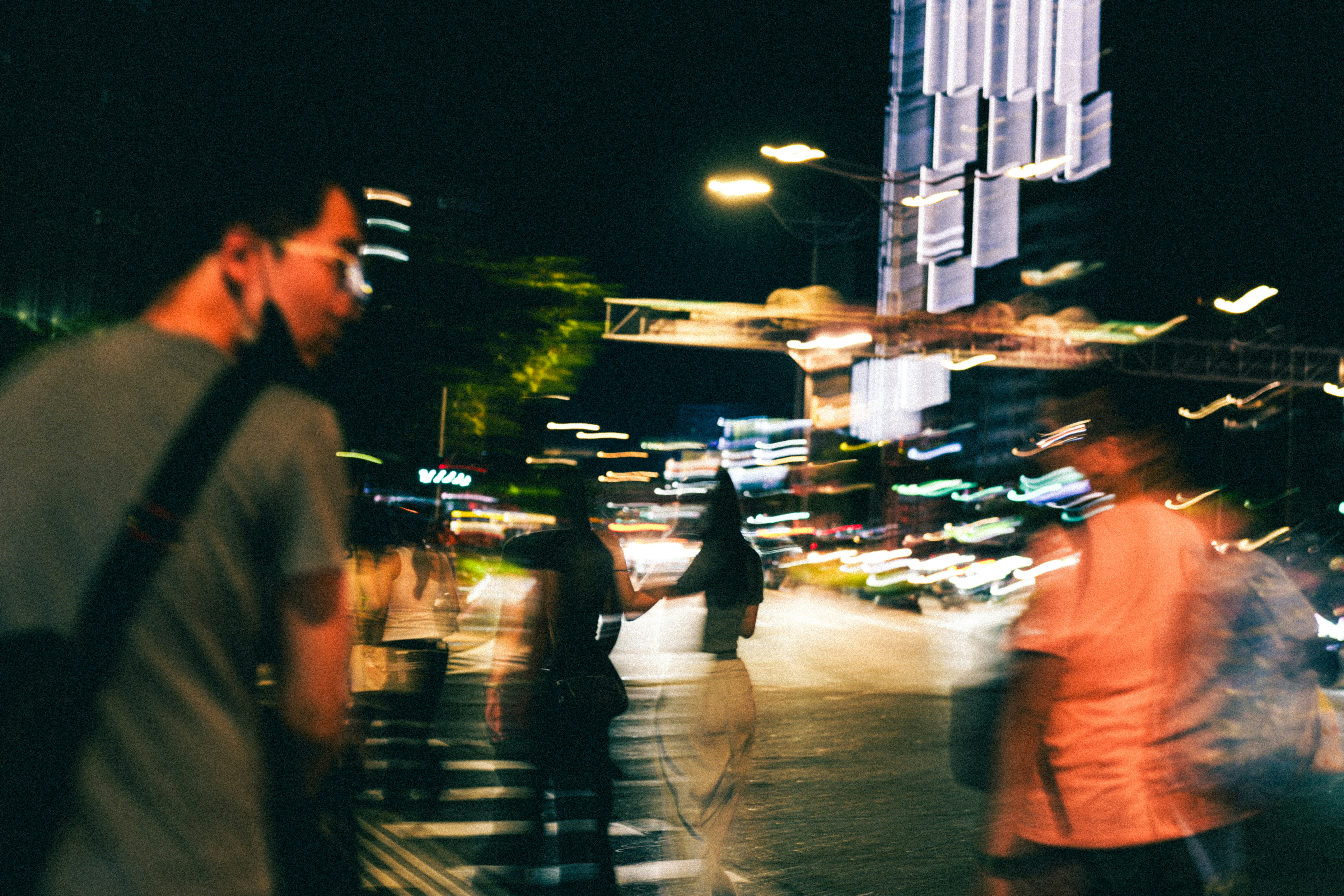Night Street Blur: A Glimpse of Moving Souls Under Neon Glow