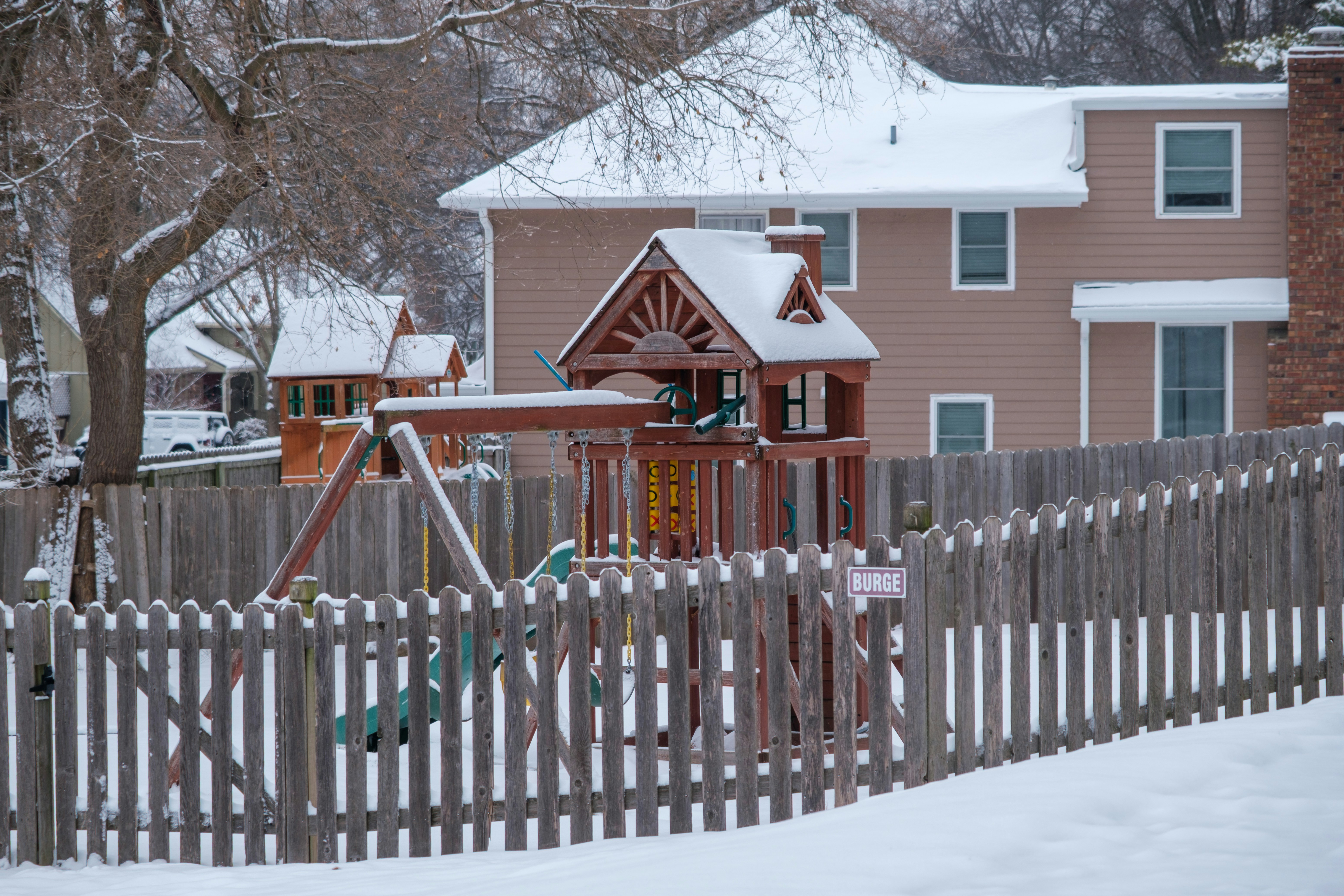 Snow-Quiet Playground Watching Over a Suburban Yard