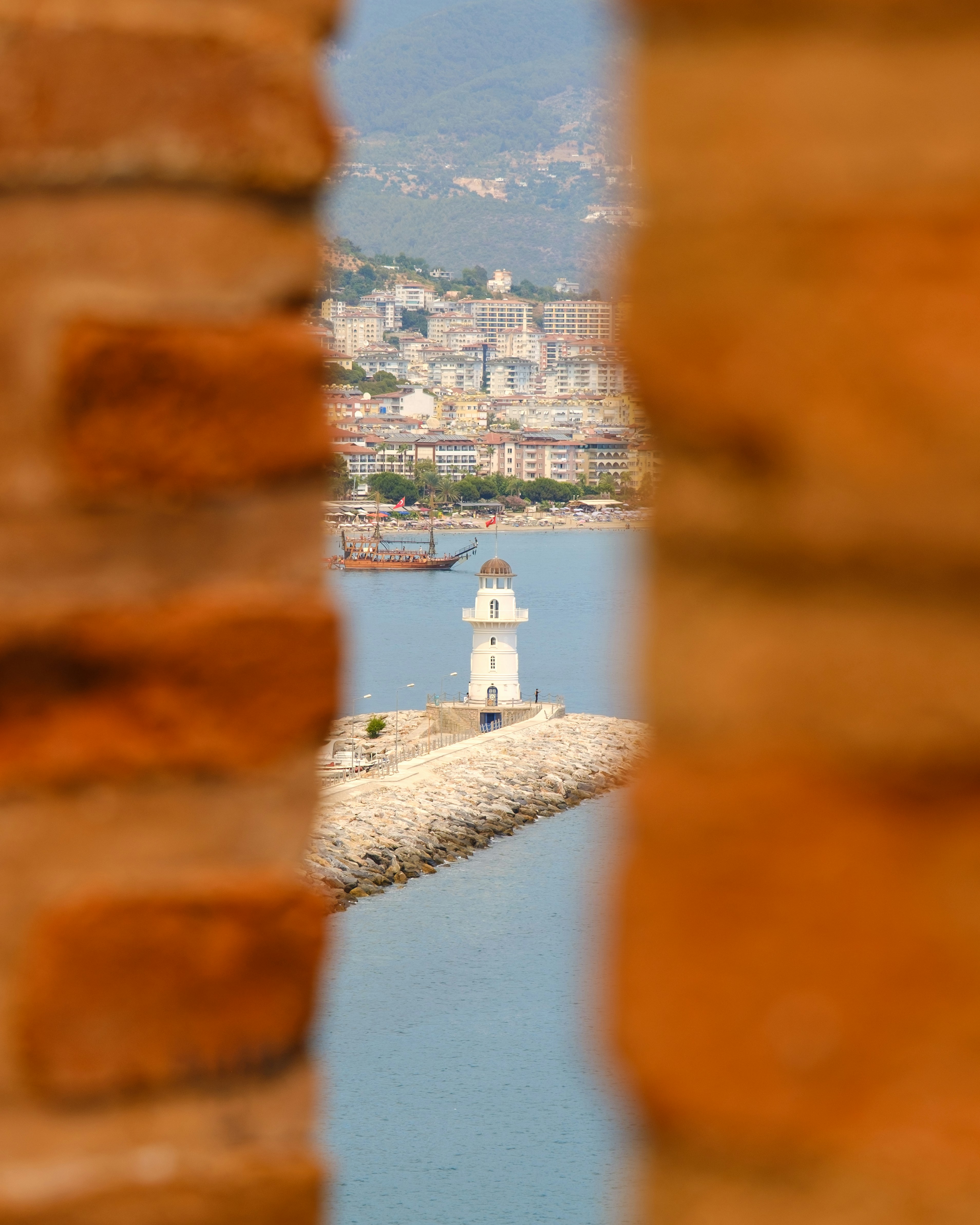 Lighthouse Through a Brick Window: Harbor Framing