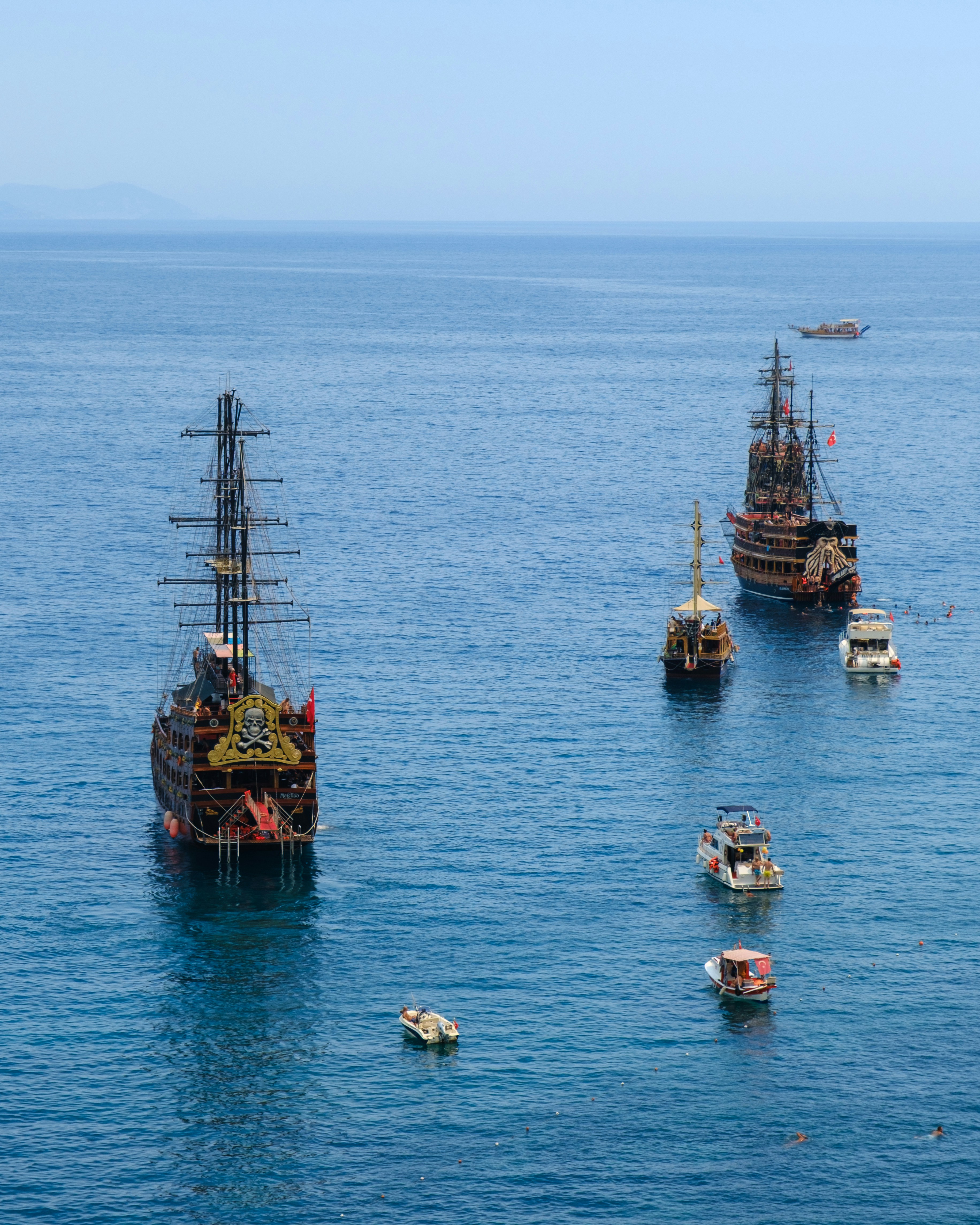 Twin Galleons at Sea: A Fleet of Carved Vessels and Distant Lights