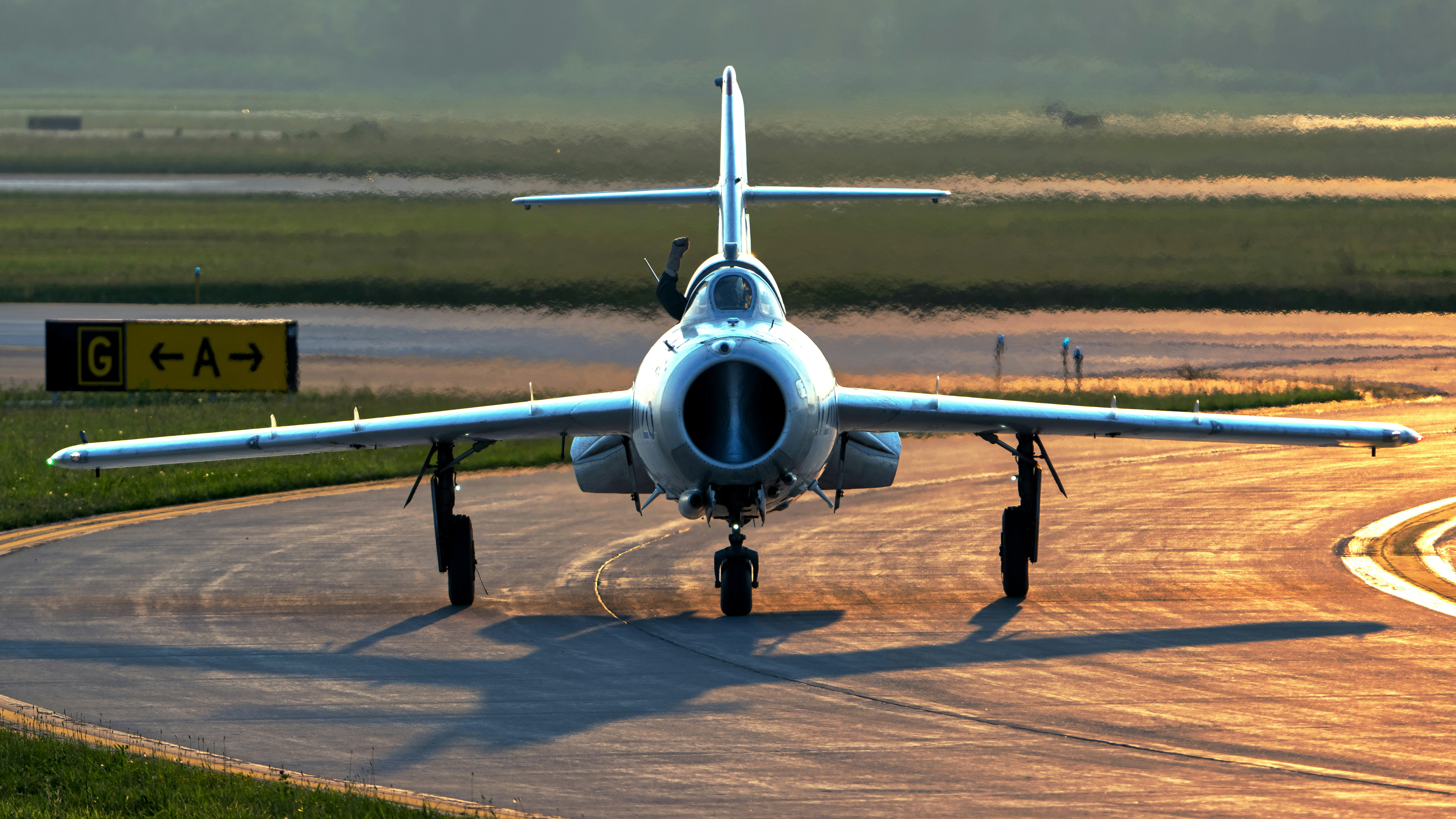 Front-on Fighter: The Jet Rolls onto the Runway at Dusk