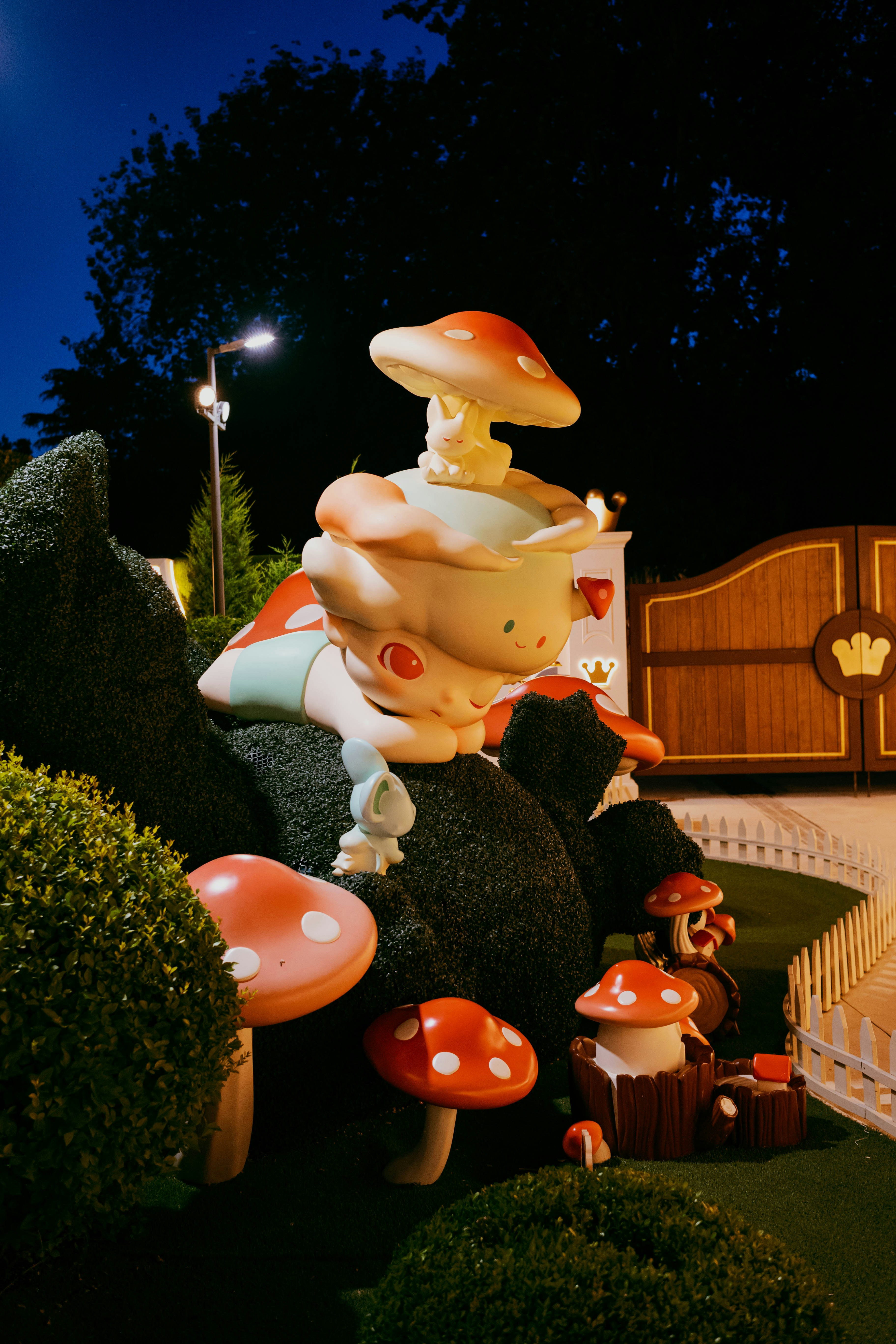 Mushroom character and red toadstools in a whimsical night garden.