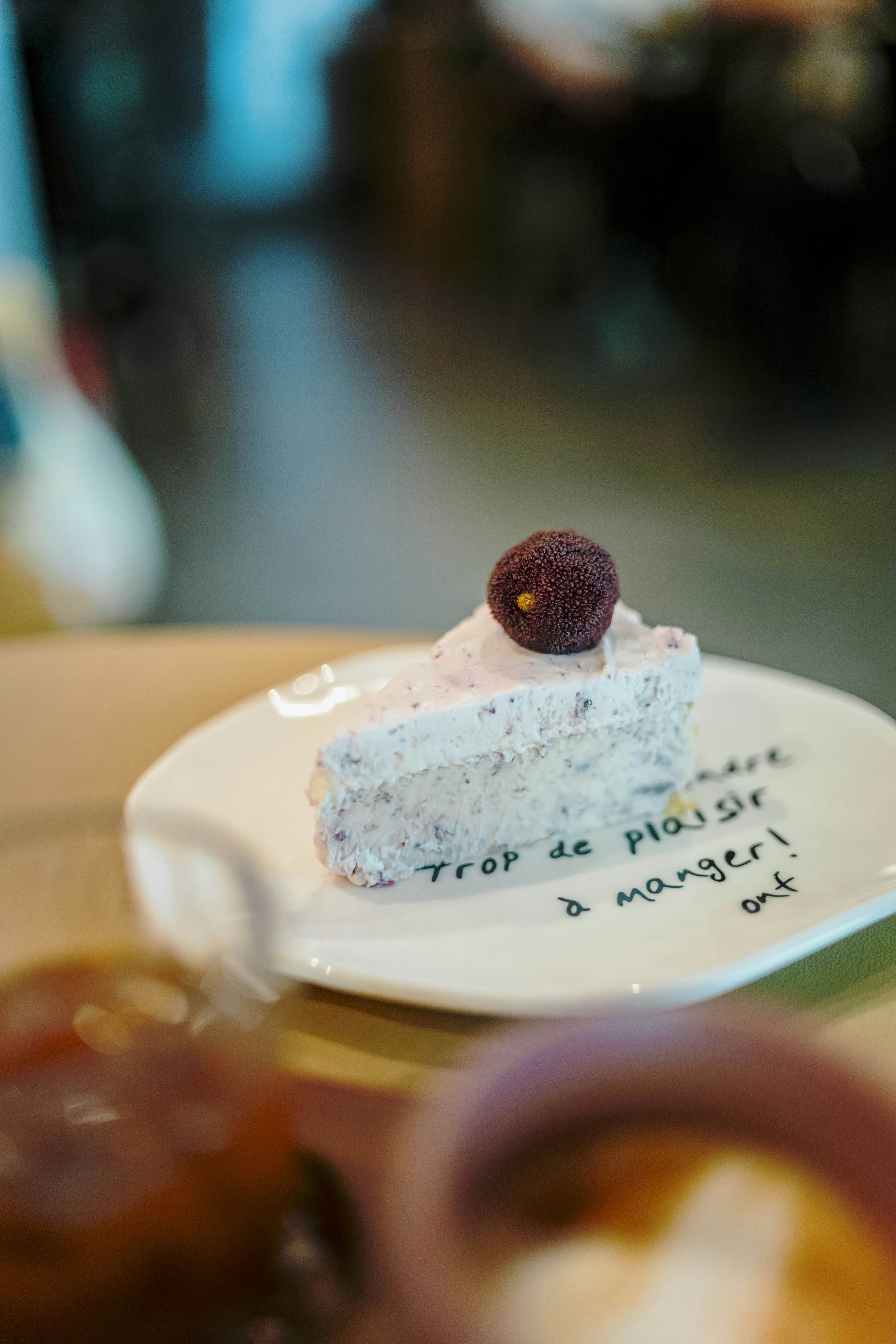 Slice of Vanilla Moon: A Cherry-Topped Cheesecake on a Quiet Plate