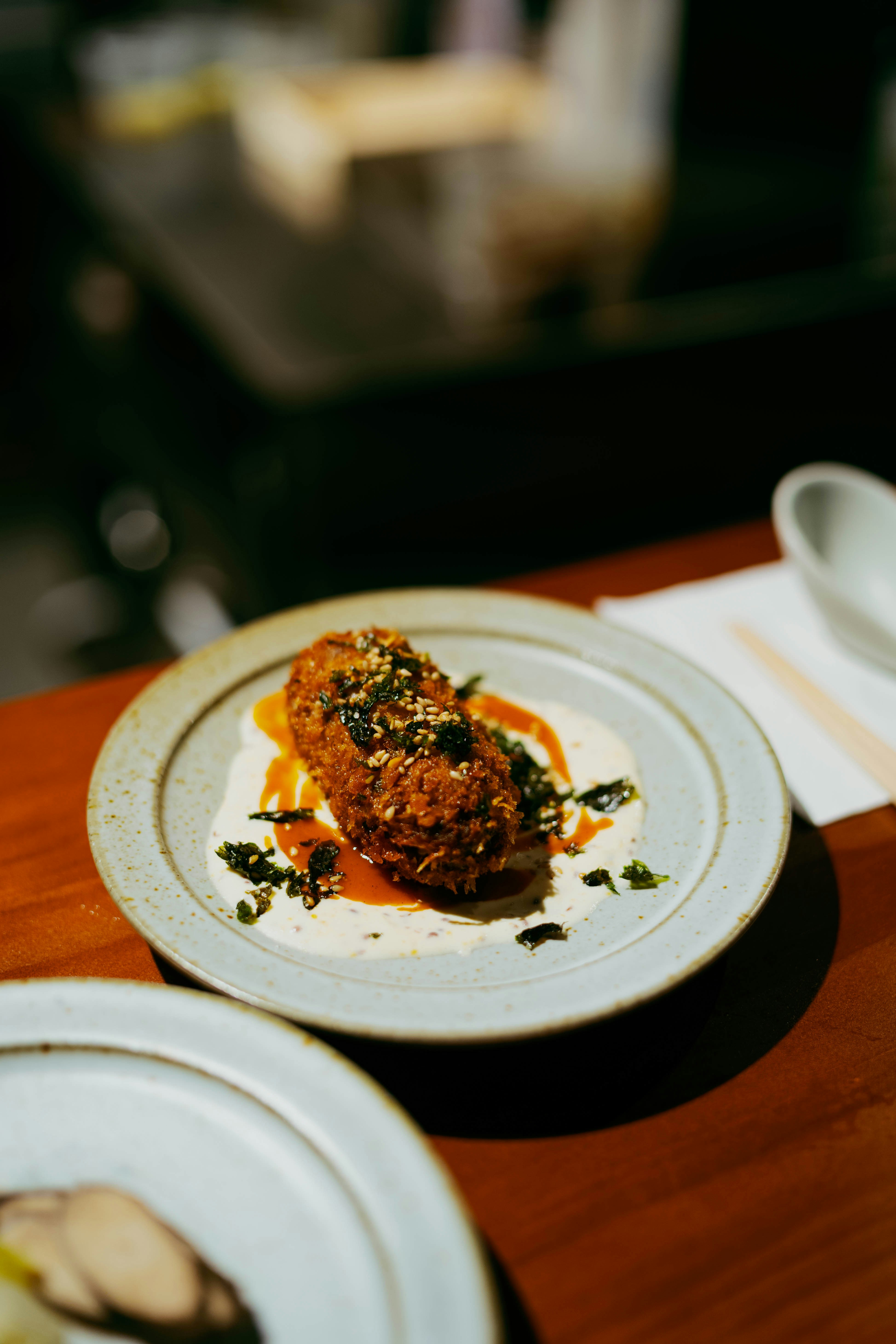 Crispy Croquette Drizzle: A Golden Bite on Creamy Plating