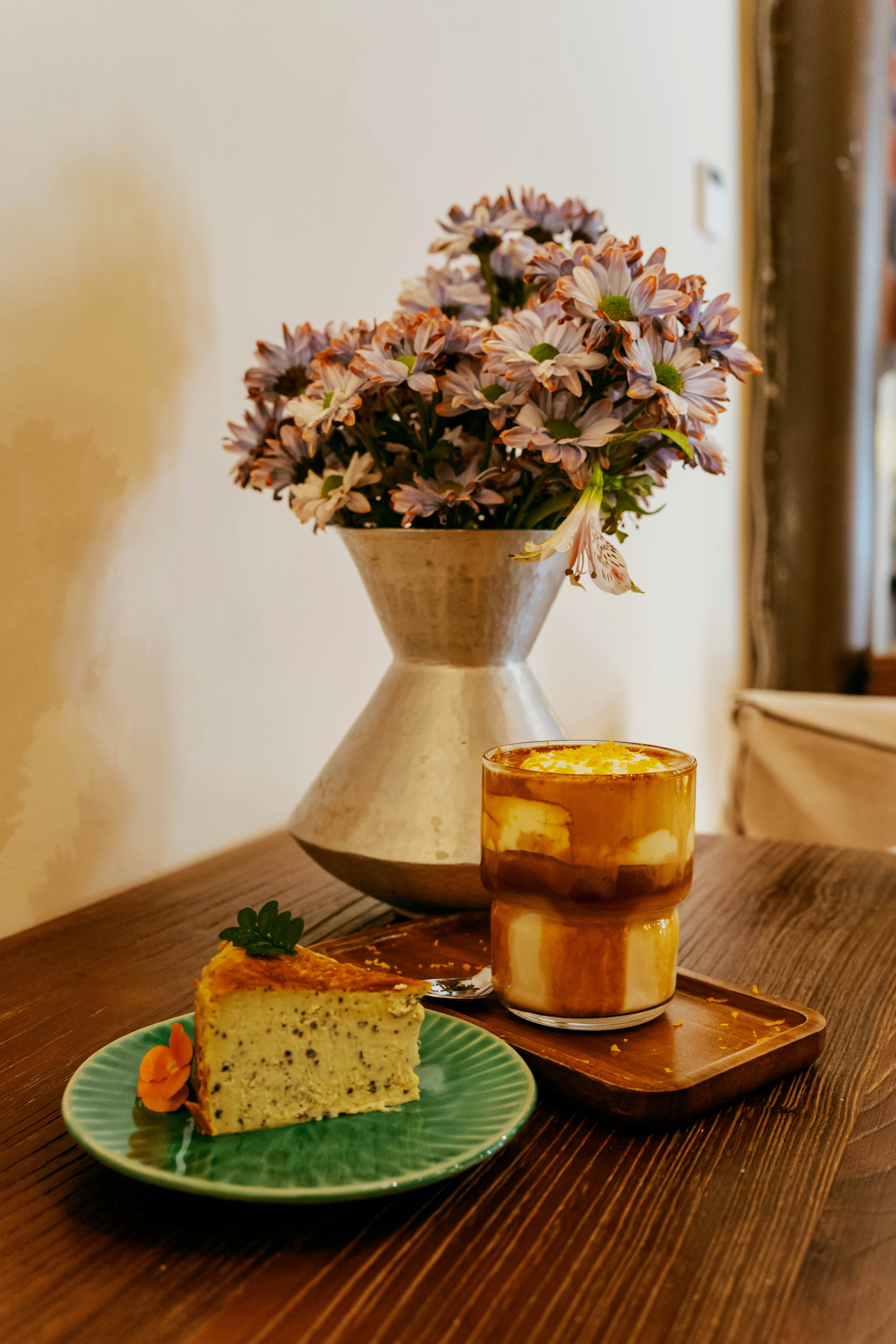 Floral Still Life with Pastry and Cake on a Wooden Table