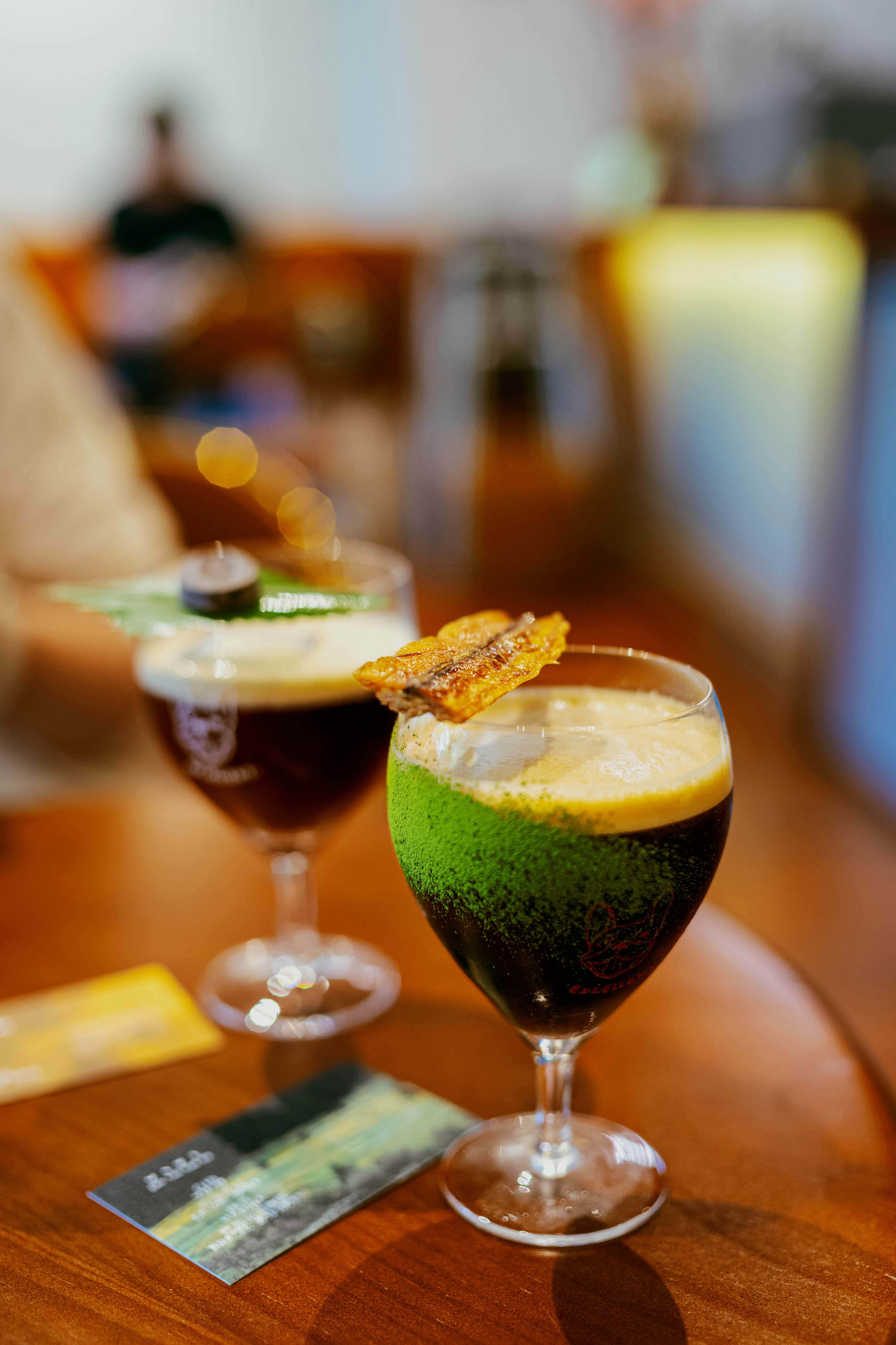 Two Glowingly Crafted Stouts: A Twist of Citrus and Crunch on a Bar Table