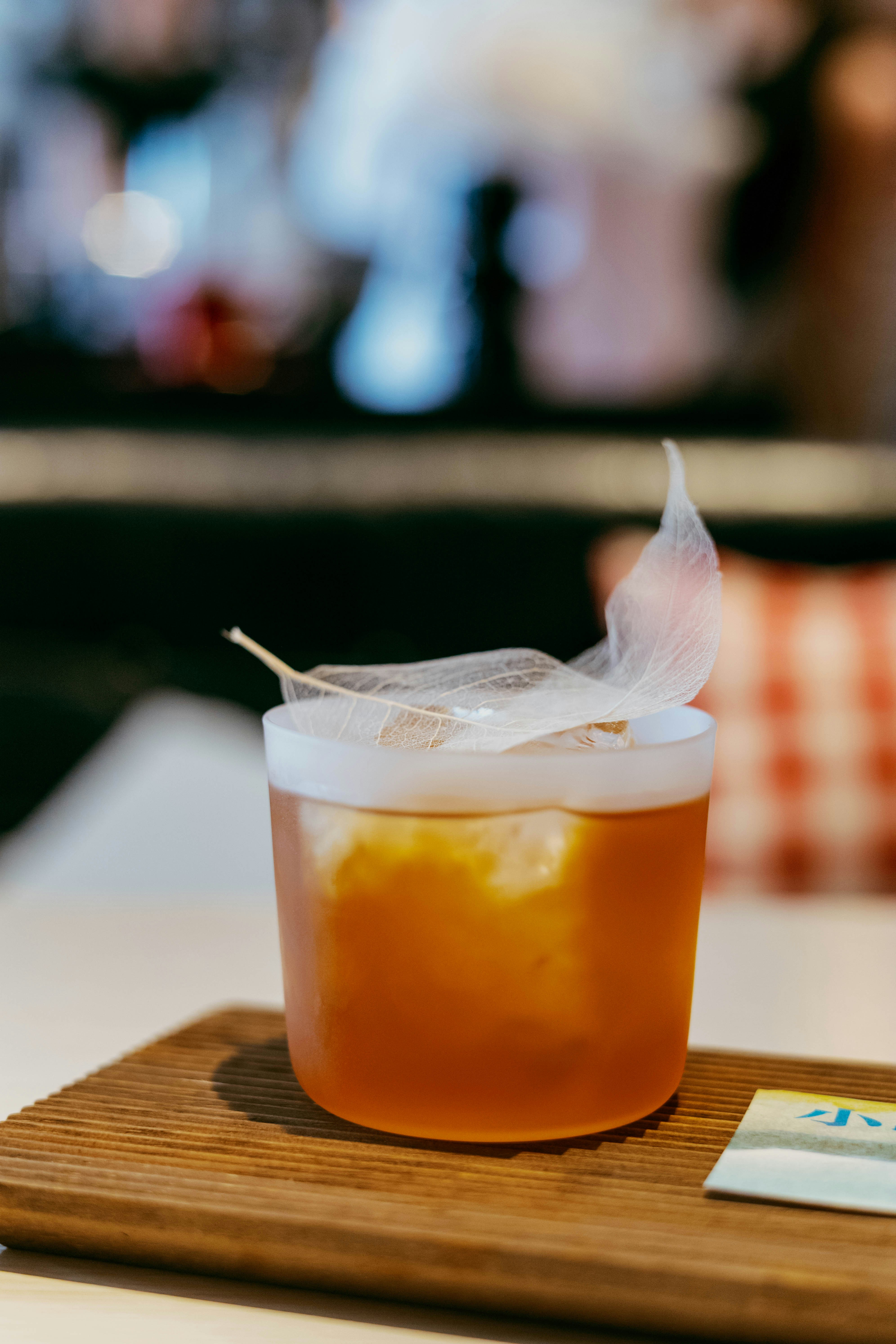 Amber Glow: A Tumble of Foam and Warm Light on a Wooden Tray