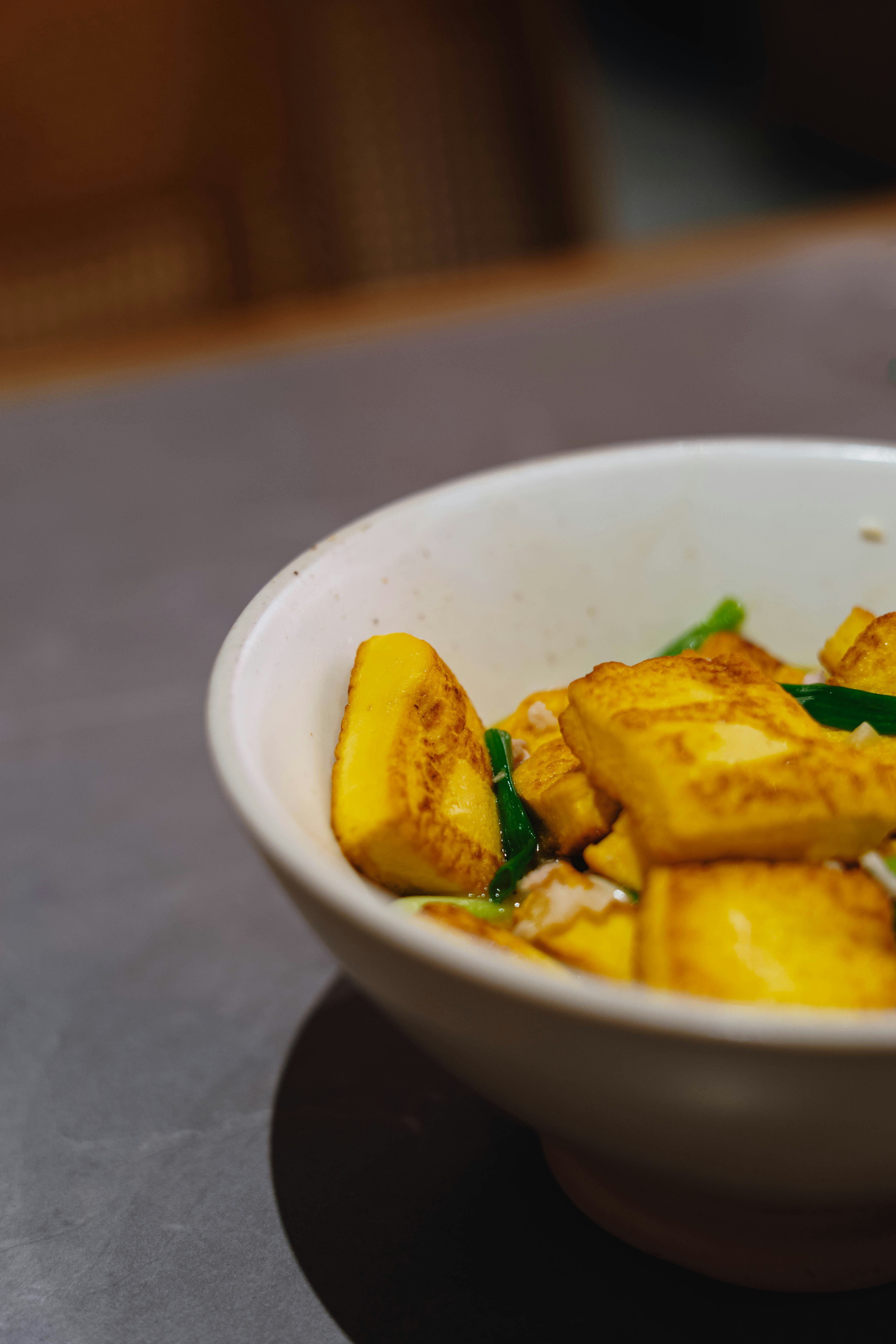 Curried Crisp: Golden Tofu Bits in a White Bowl