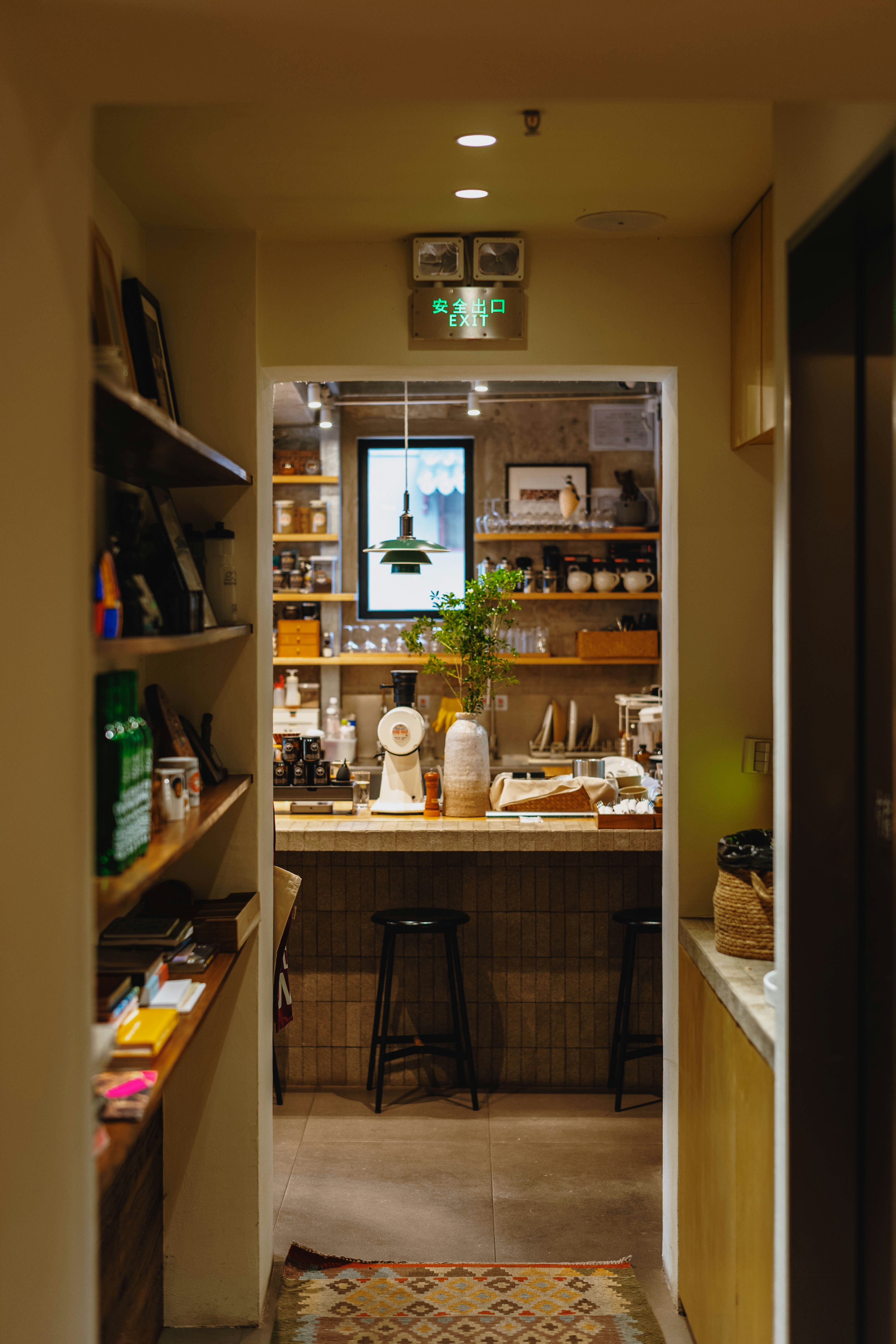 Warm Café Corridor: A Quiet Corner Beneath The Exit Light