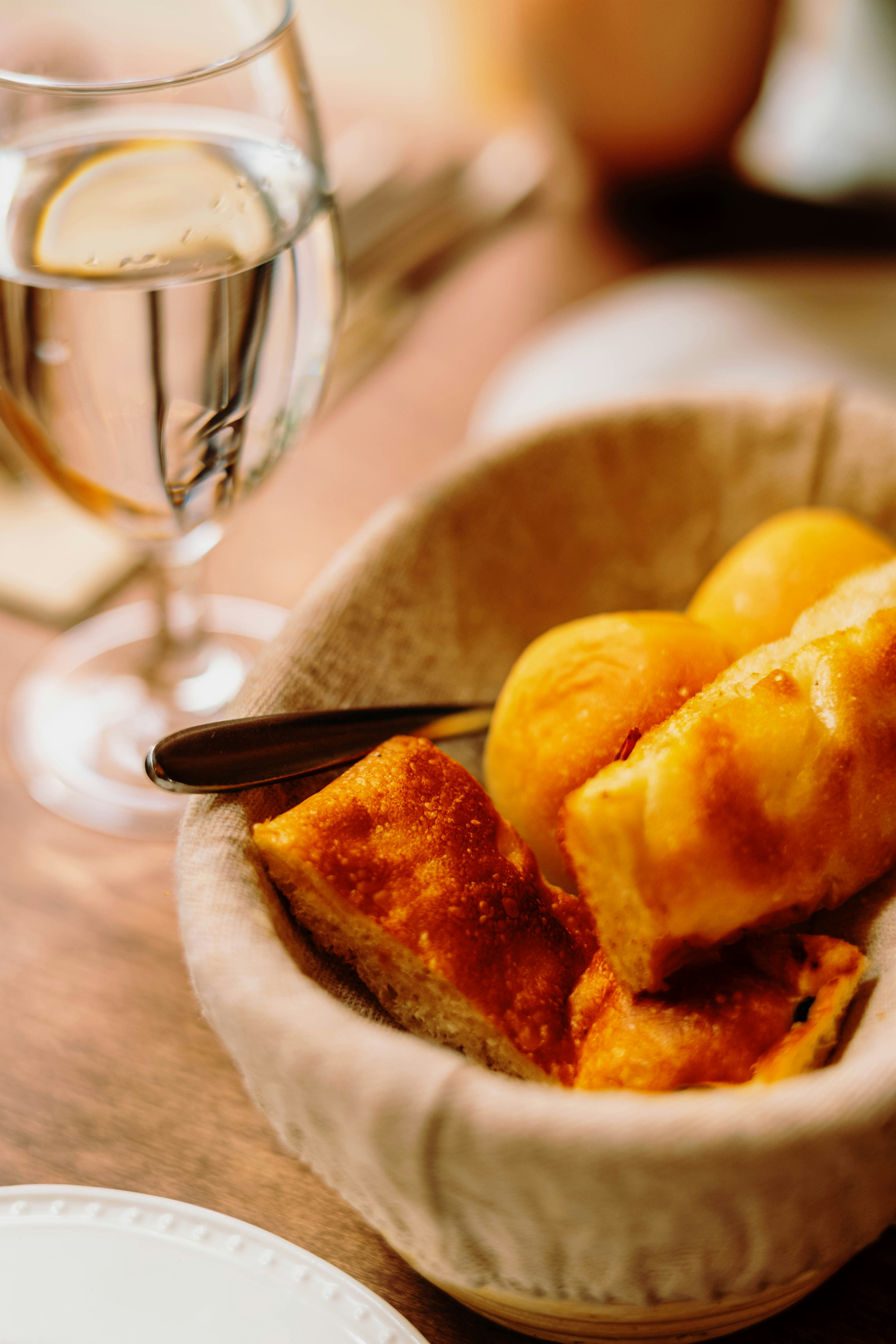 Golden Bites in a Linen Bowl by the Glass of Water