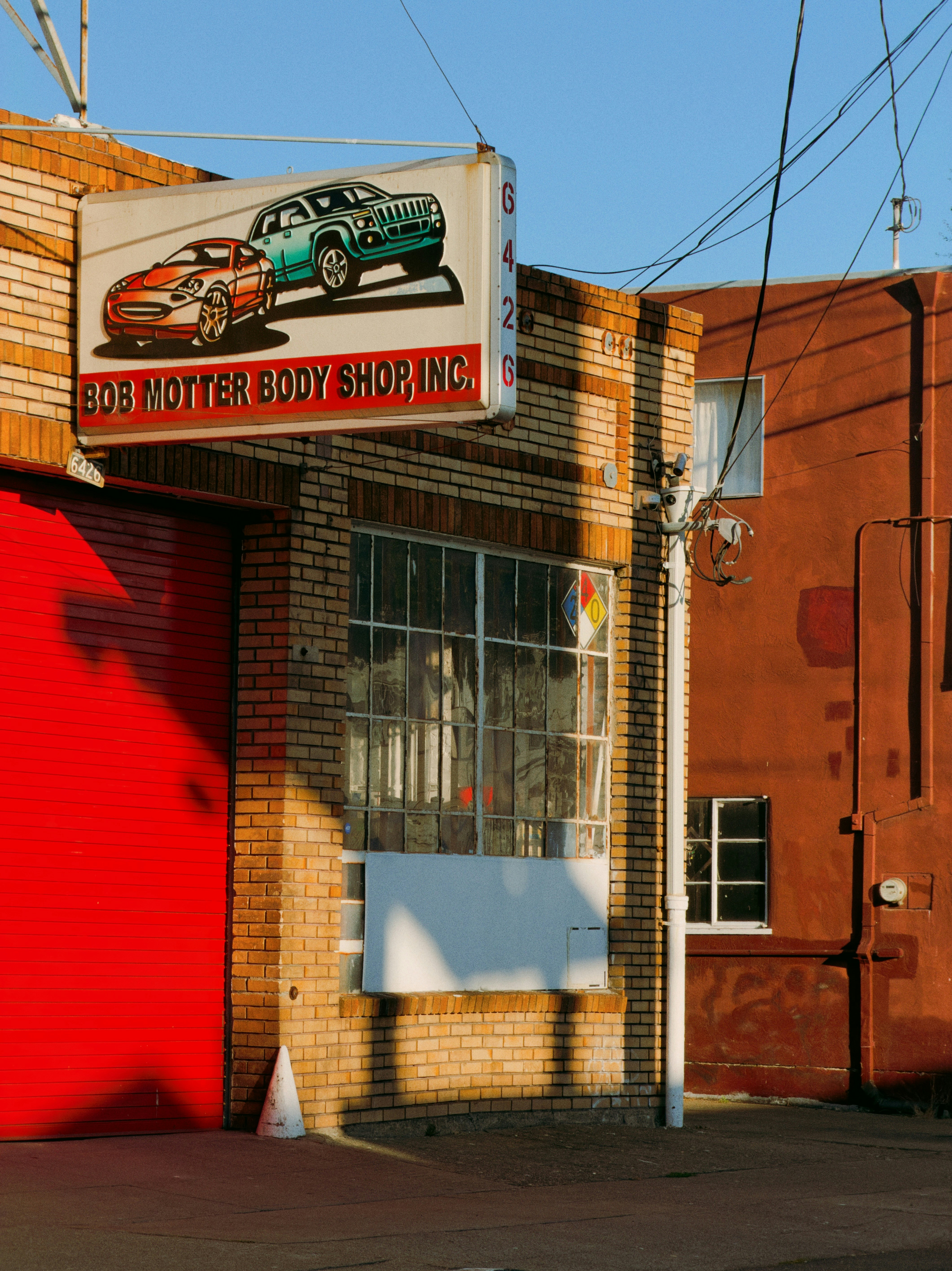 Neon Red Garage Door and sign at the Corner Shop