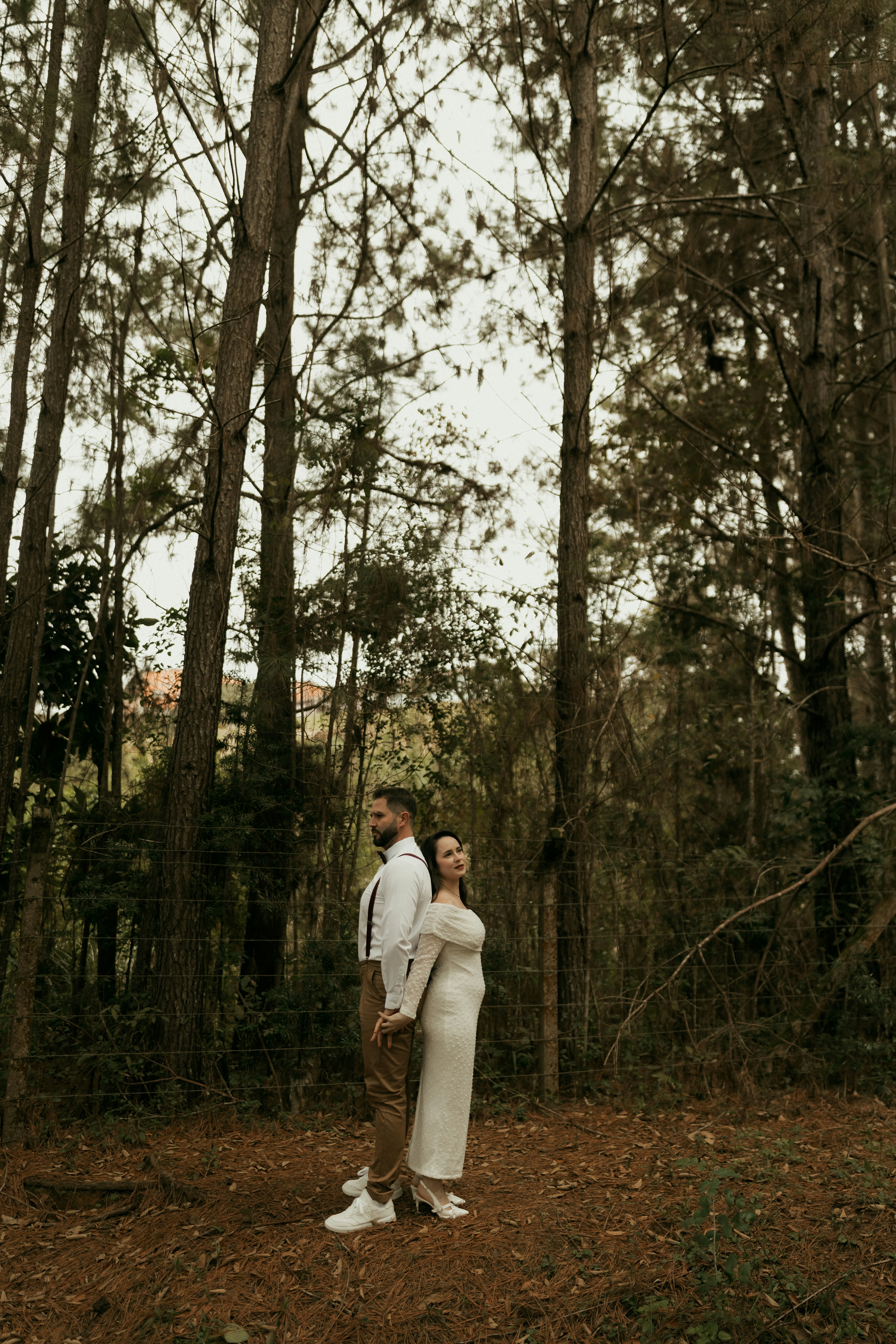 Twin silhouettes in a forest: a quiet embrace