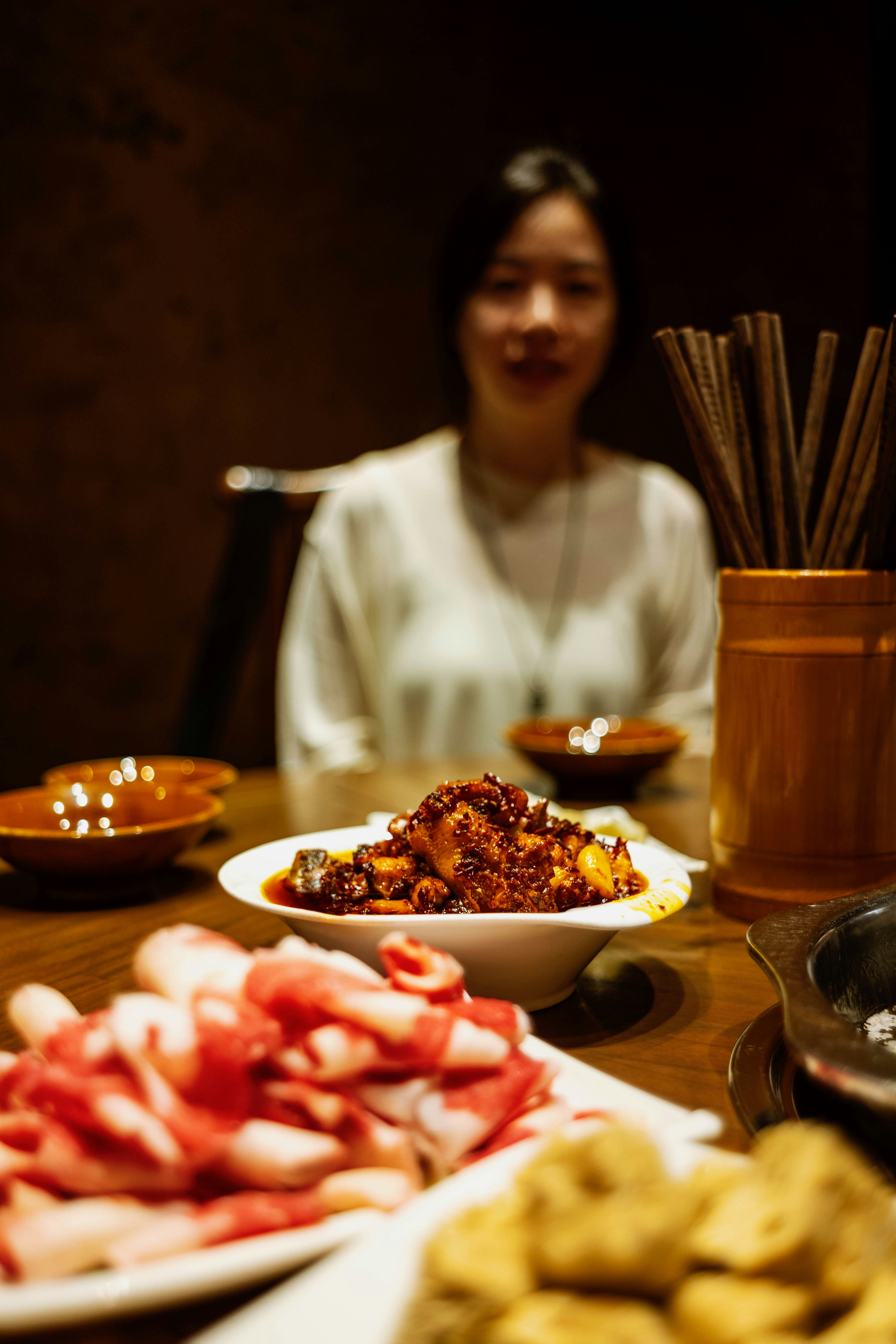 Dim Sum Moment: A Quiet Dining Scene with a Blurred Guest Behind the Table