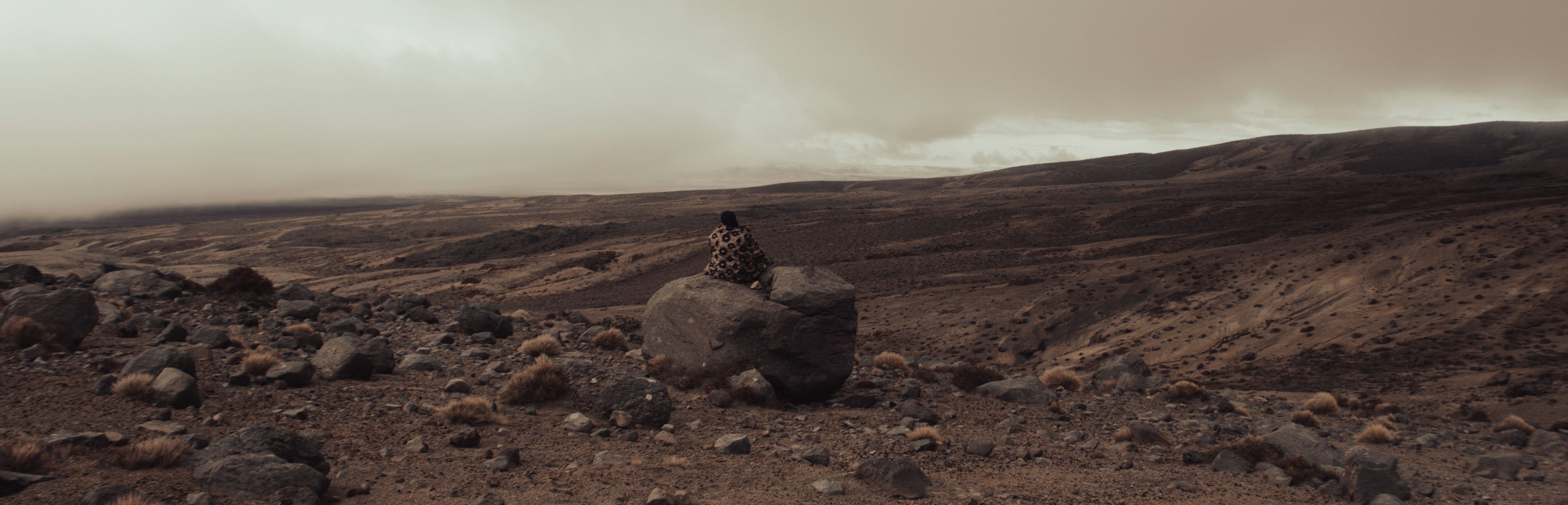 Stone sentinel under a vast basaltic sky