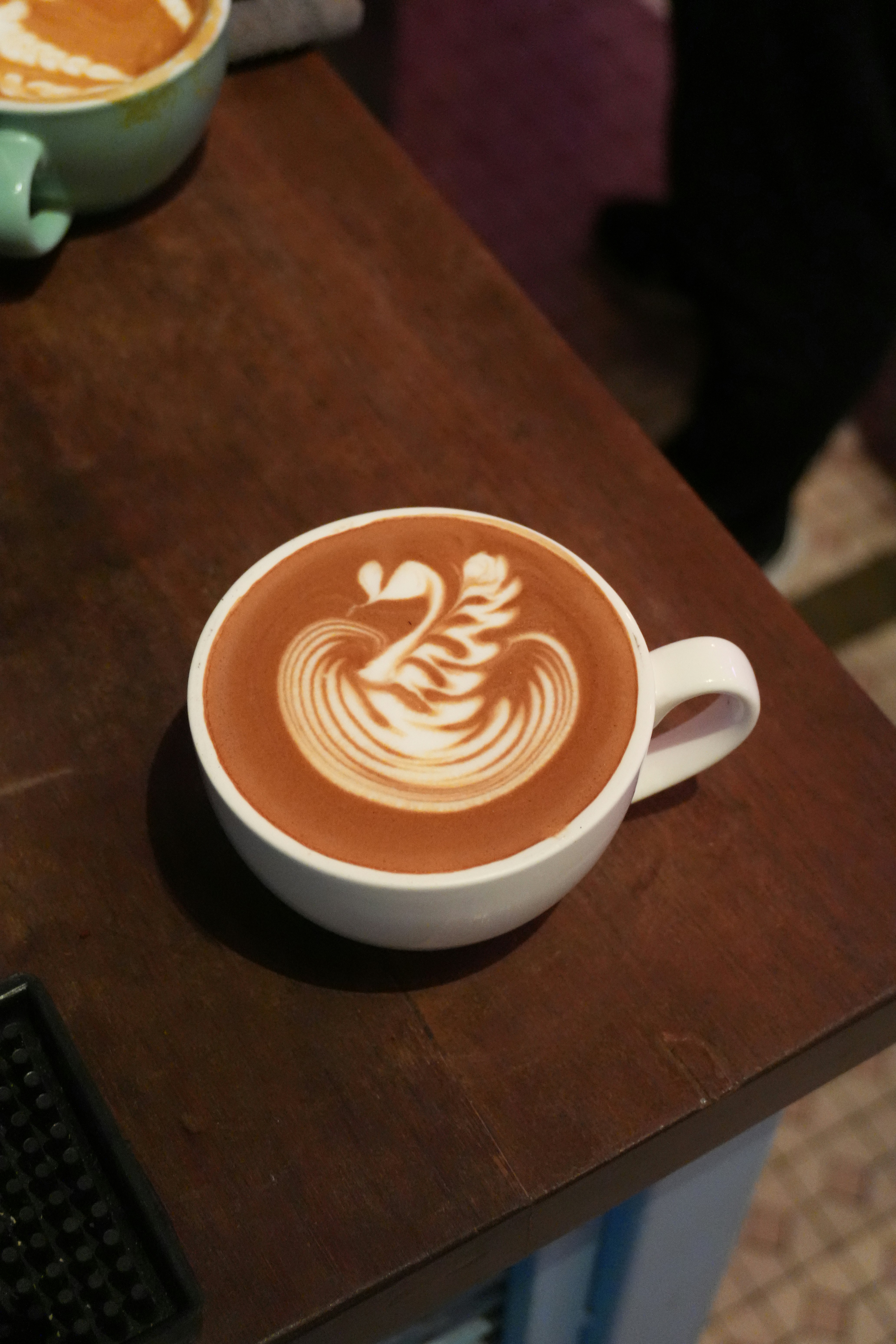 Cup of Craft: Cocoa Swirl Portrait on a Wooden Table