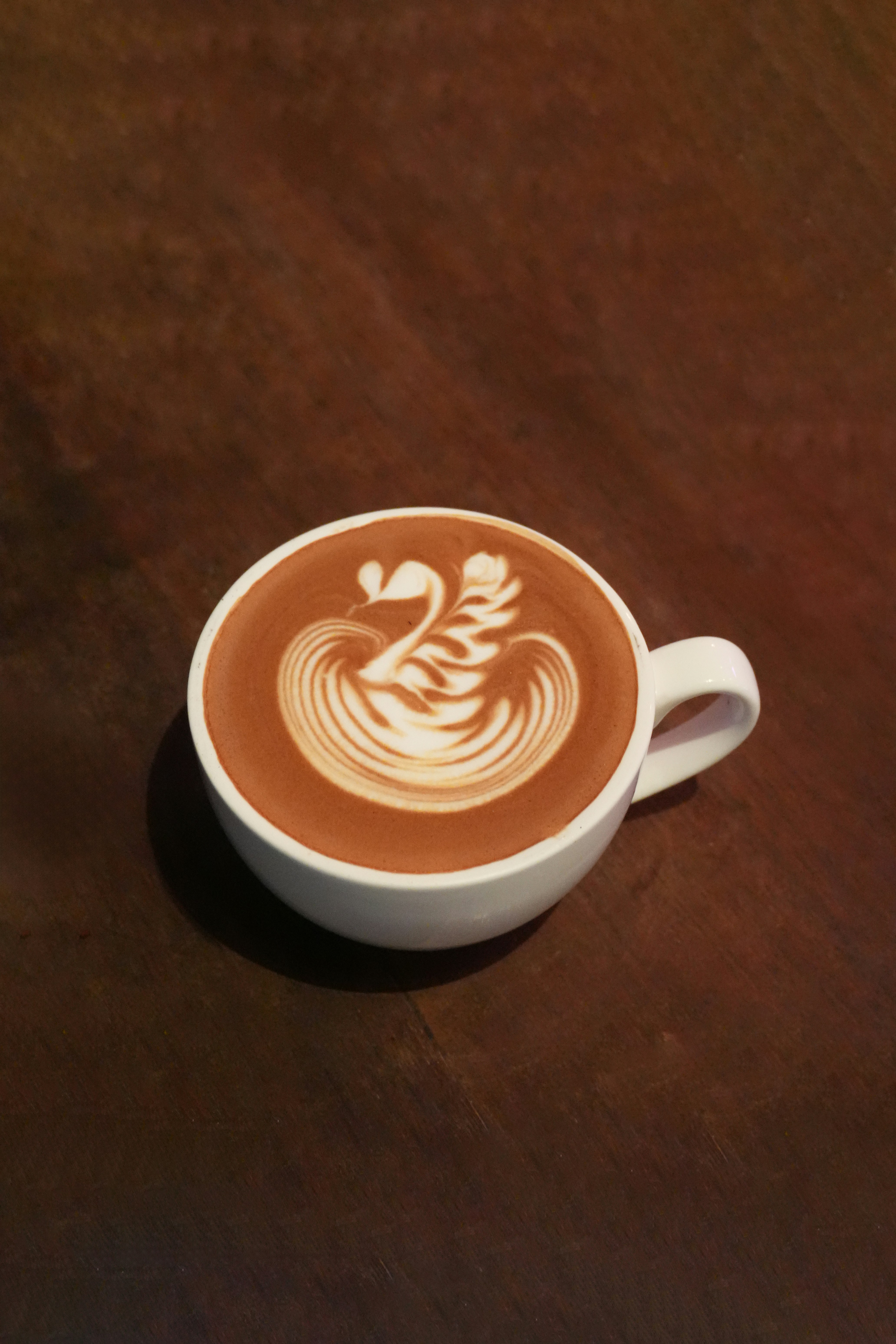 Latte Art Swan Over a Rustic Table