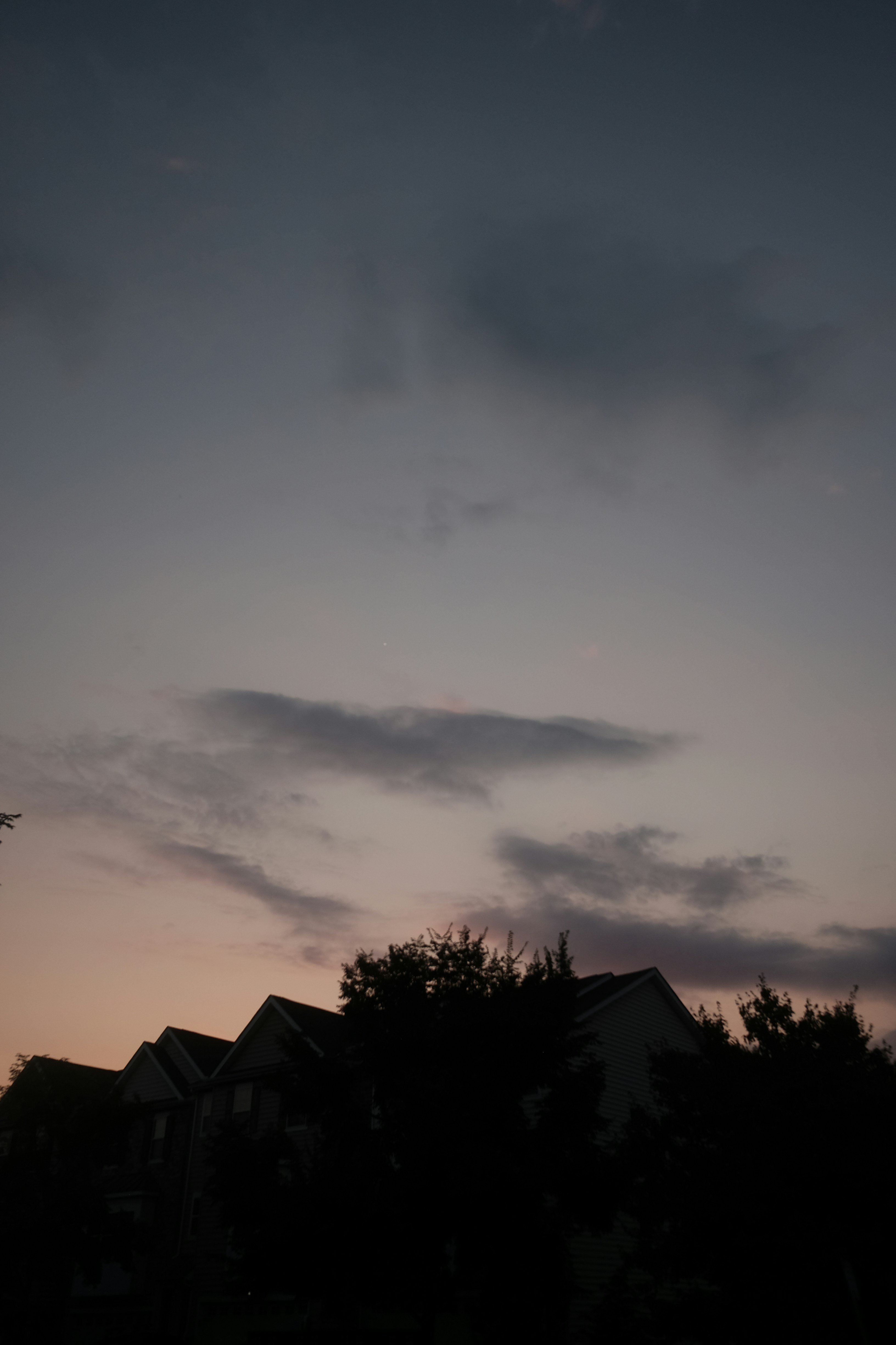 Dusk Silhouette Over Quiet Suburban Roofline