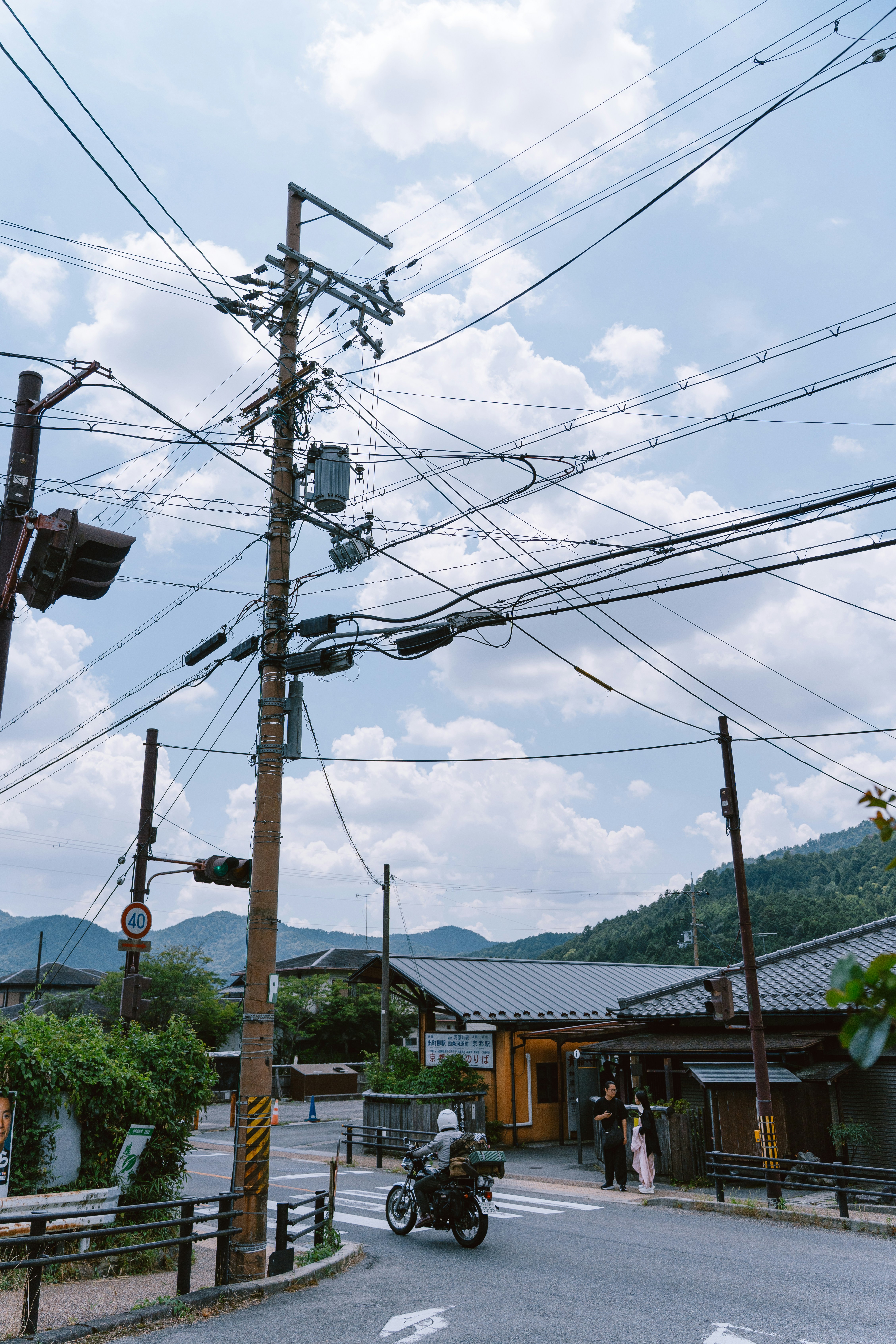 Cable Forest Overhead: A Quiet Street Under a Web of Wires