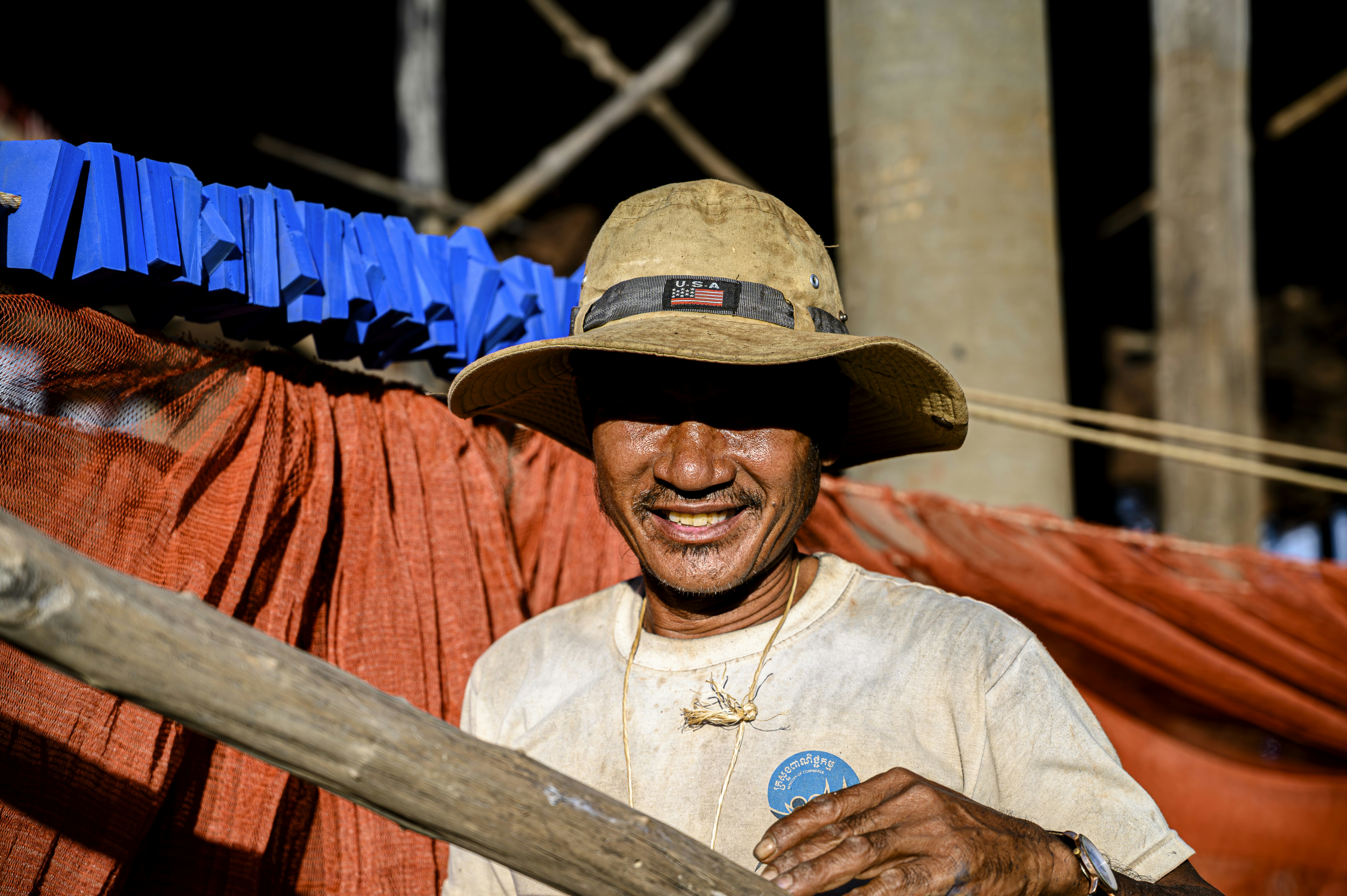 Sunlit Harvester: A Weathered Hat, Warm Smile