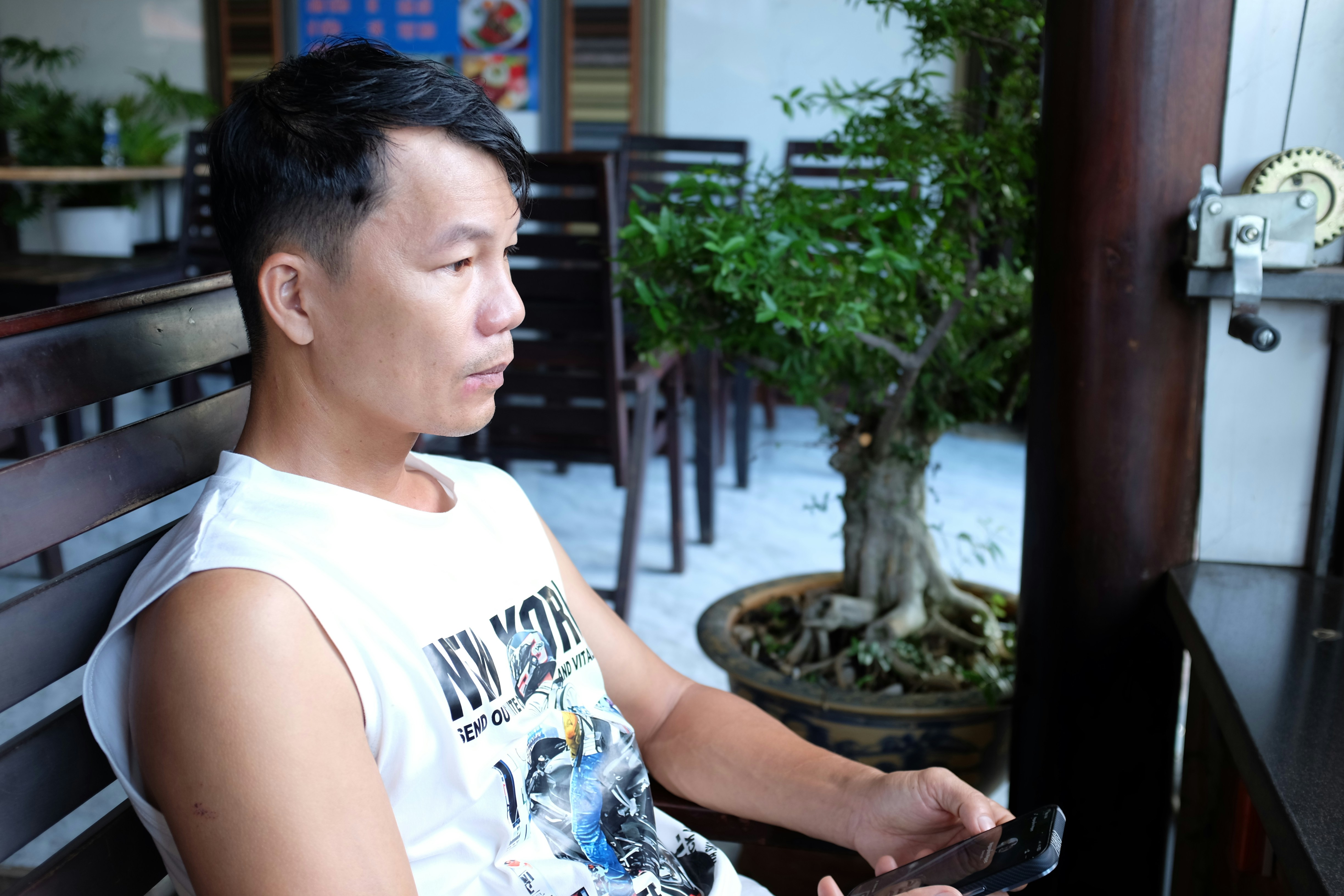 Quiet Moments: A Seated Portrait in Ambient Cafe Light