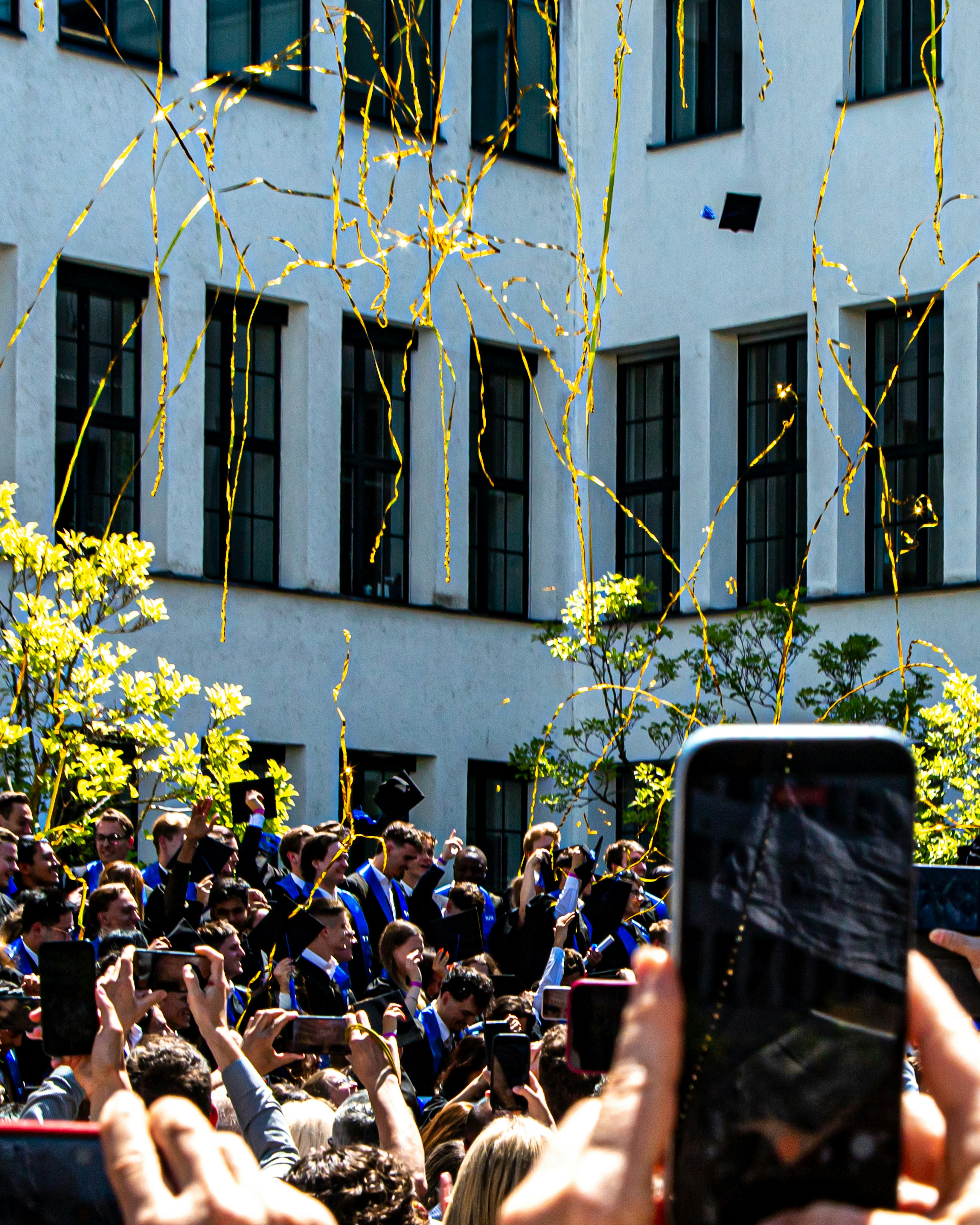 Celebration Under Golden Streamers: A Crowd Captures a Moment