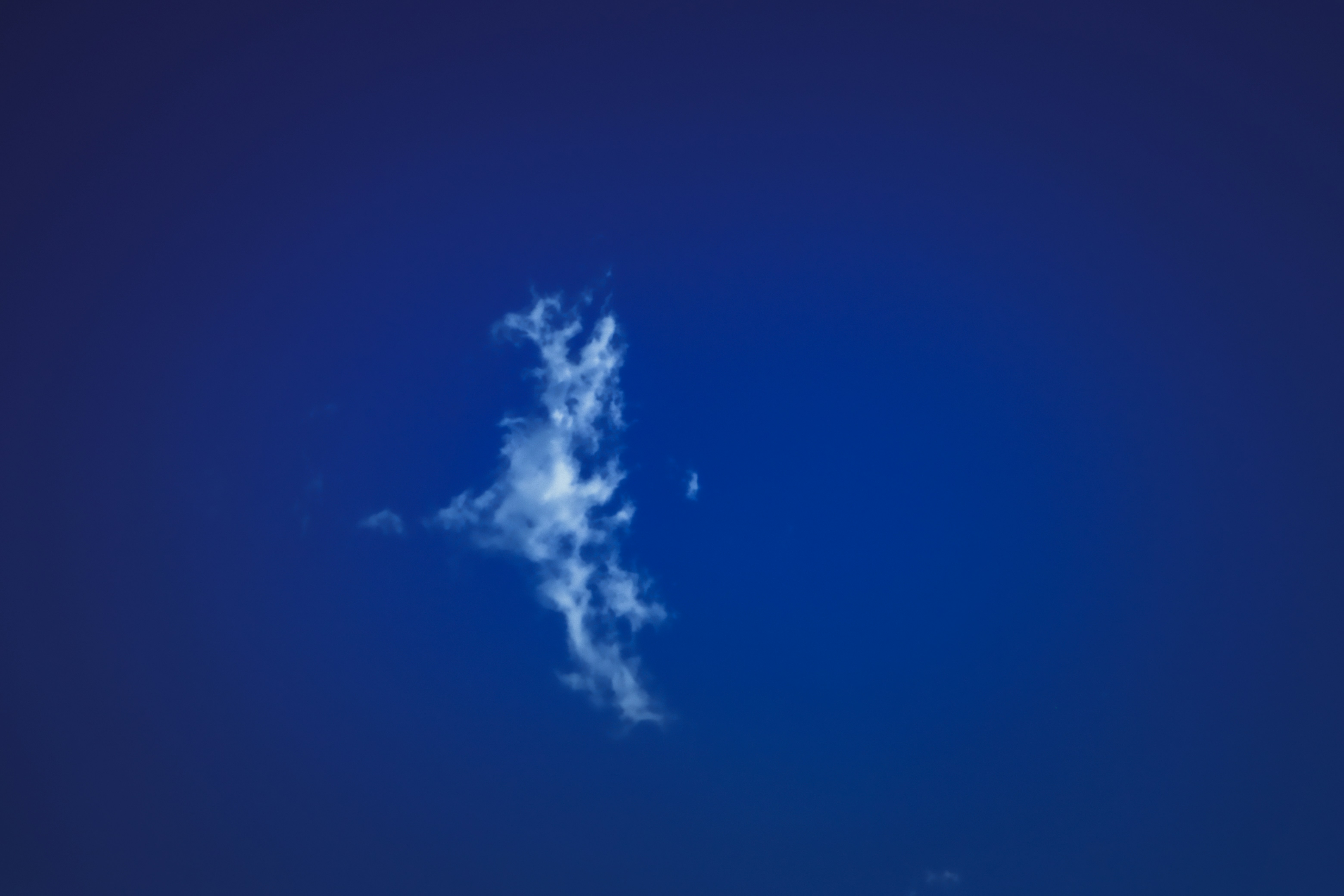A Lonesome Cloud Adrift in Deep Blue Dusk