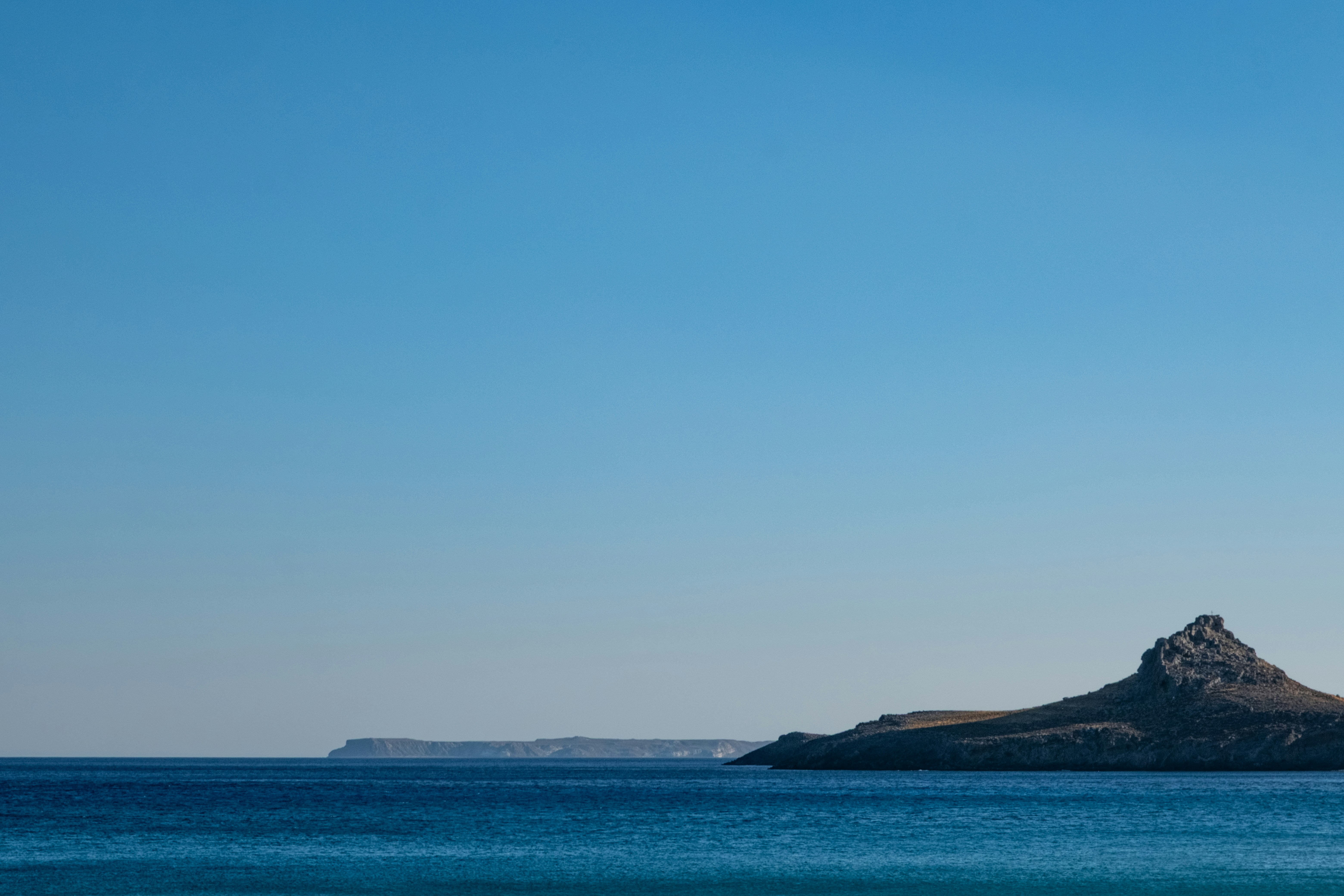 Coastal Horizon: Quiet Sea Meeting a Rugged Headland