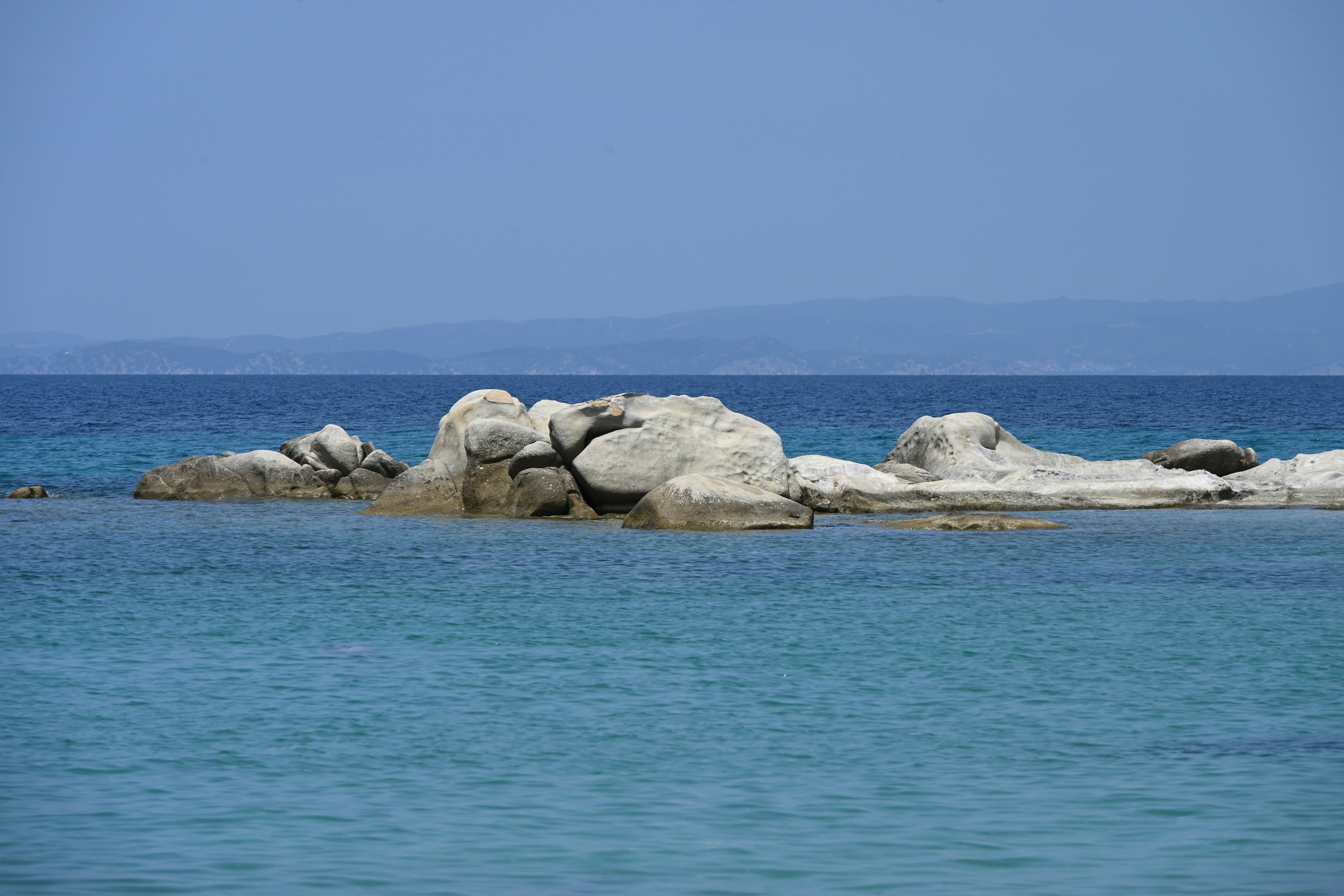 Calm Sea Sketch: Granite Islet Balanced on a Quiet Horizon