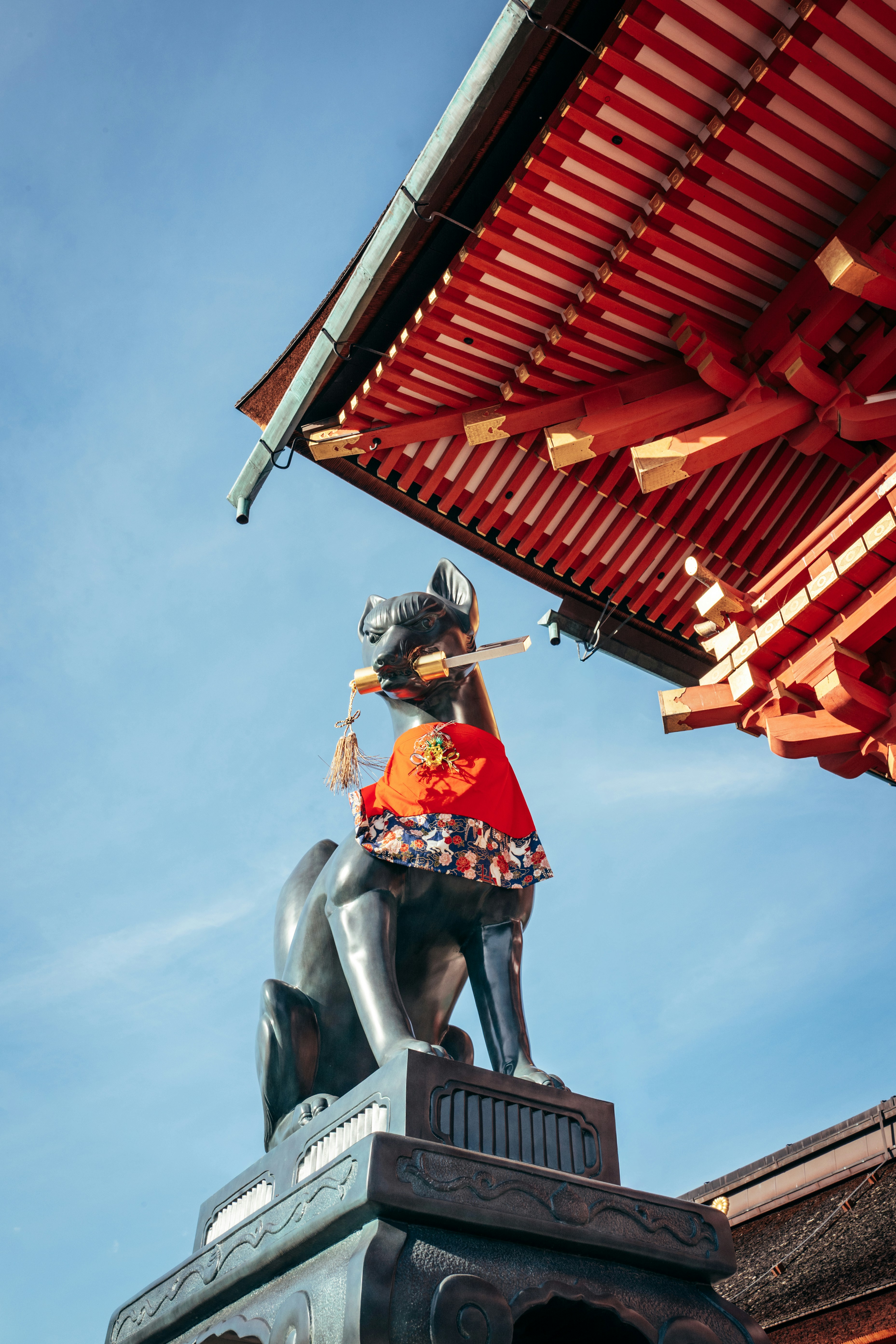 Guarded by the Temple Dog: A Shrine Guardian Statue in Vibrant Attire