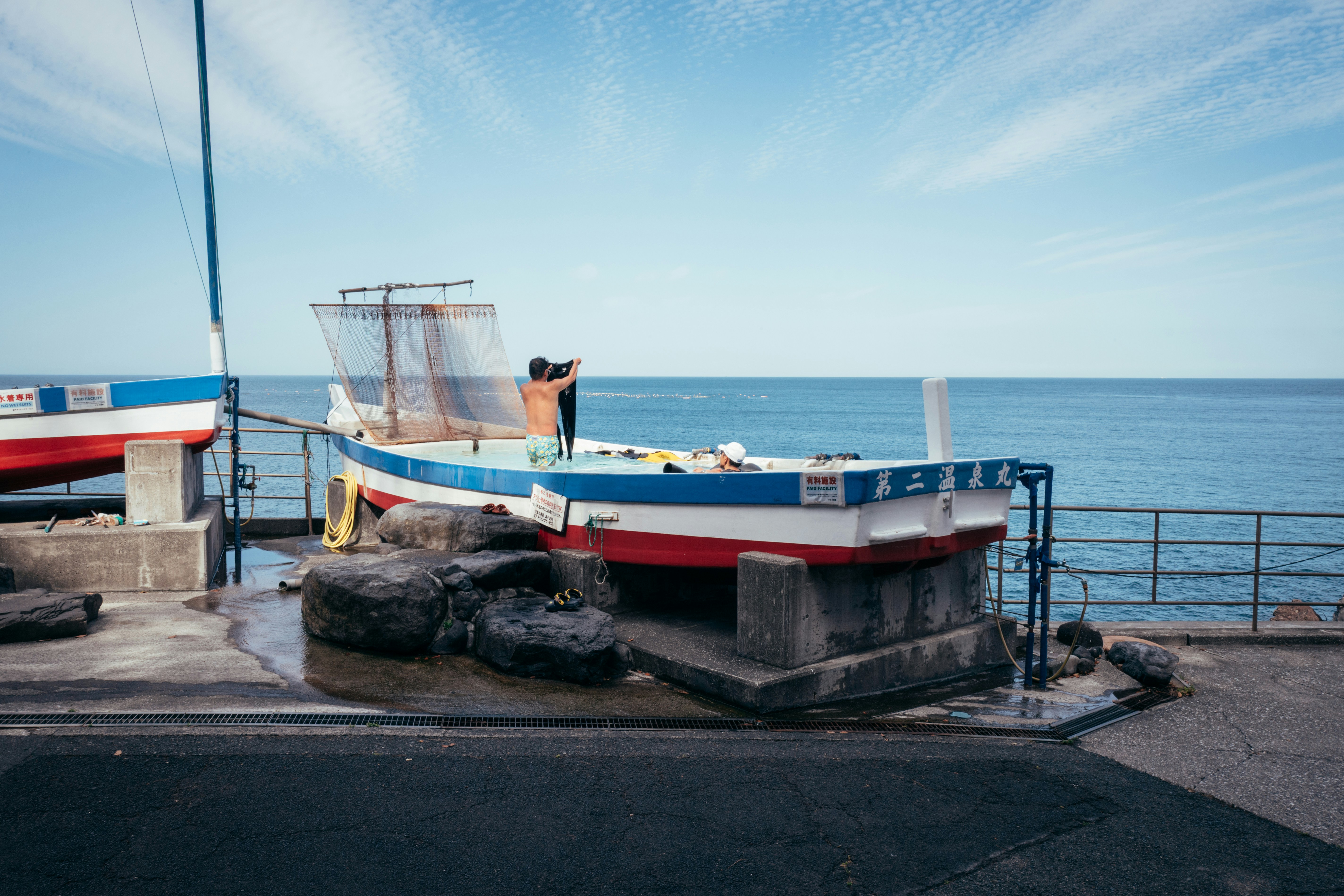 Boat Slip at Seaside Wharf with Net and Fisherman