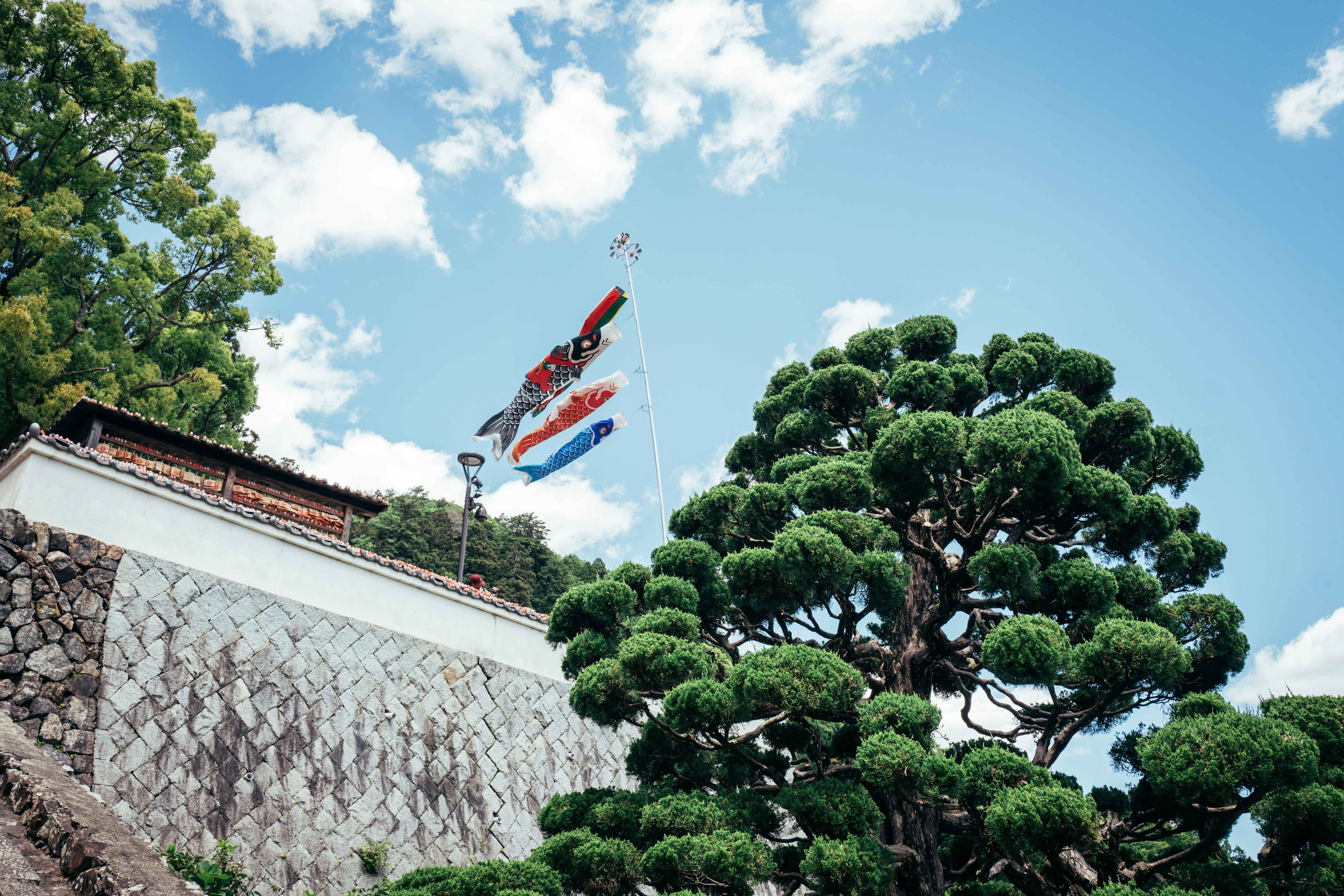 Flag Trio Above the Stone Terrace under a Clear Sky