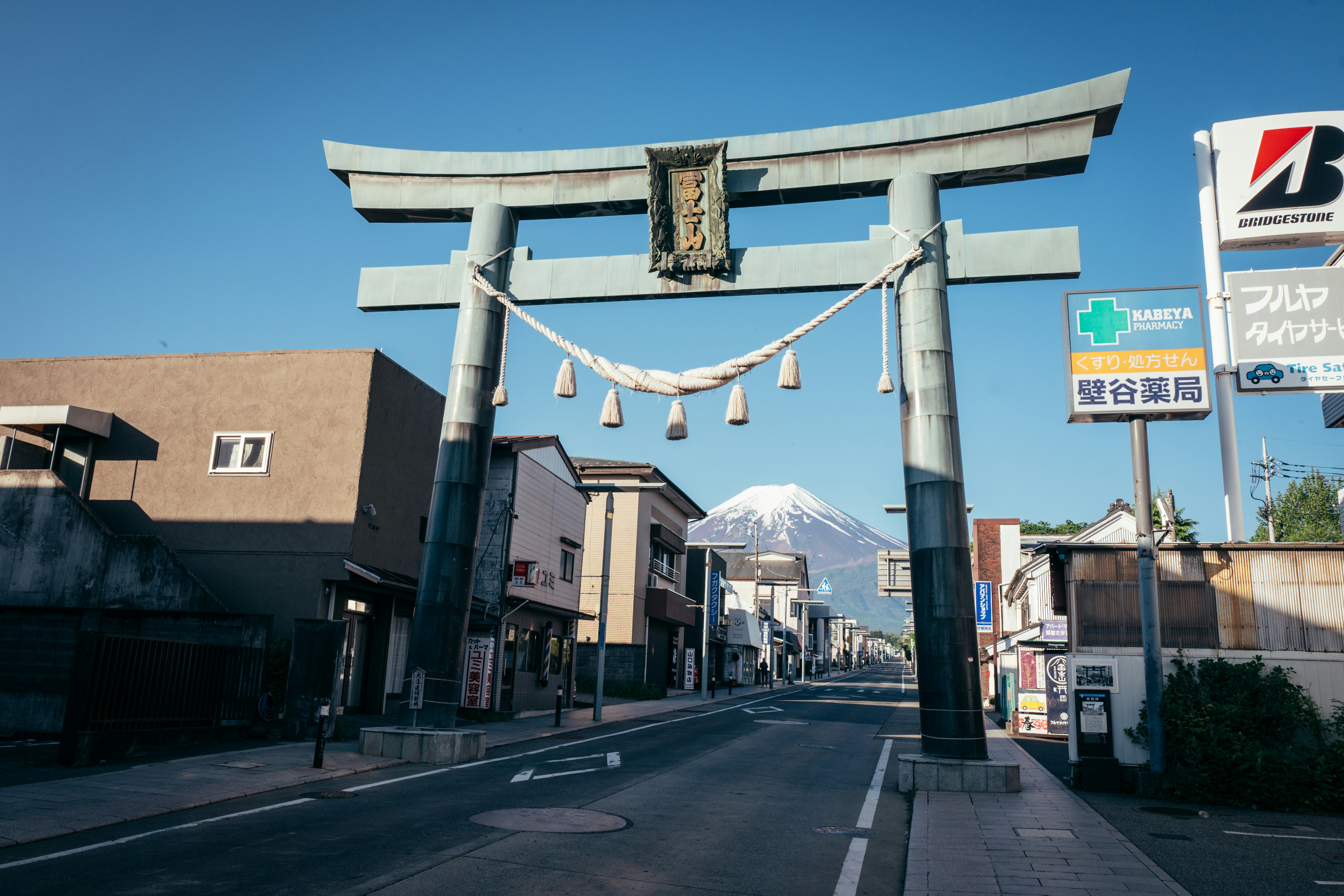 Gateway to Fuji: A Shinto Arch Frames the Street Toward Mount Fuji