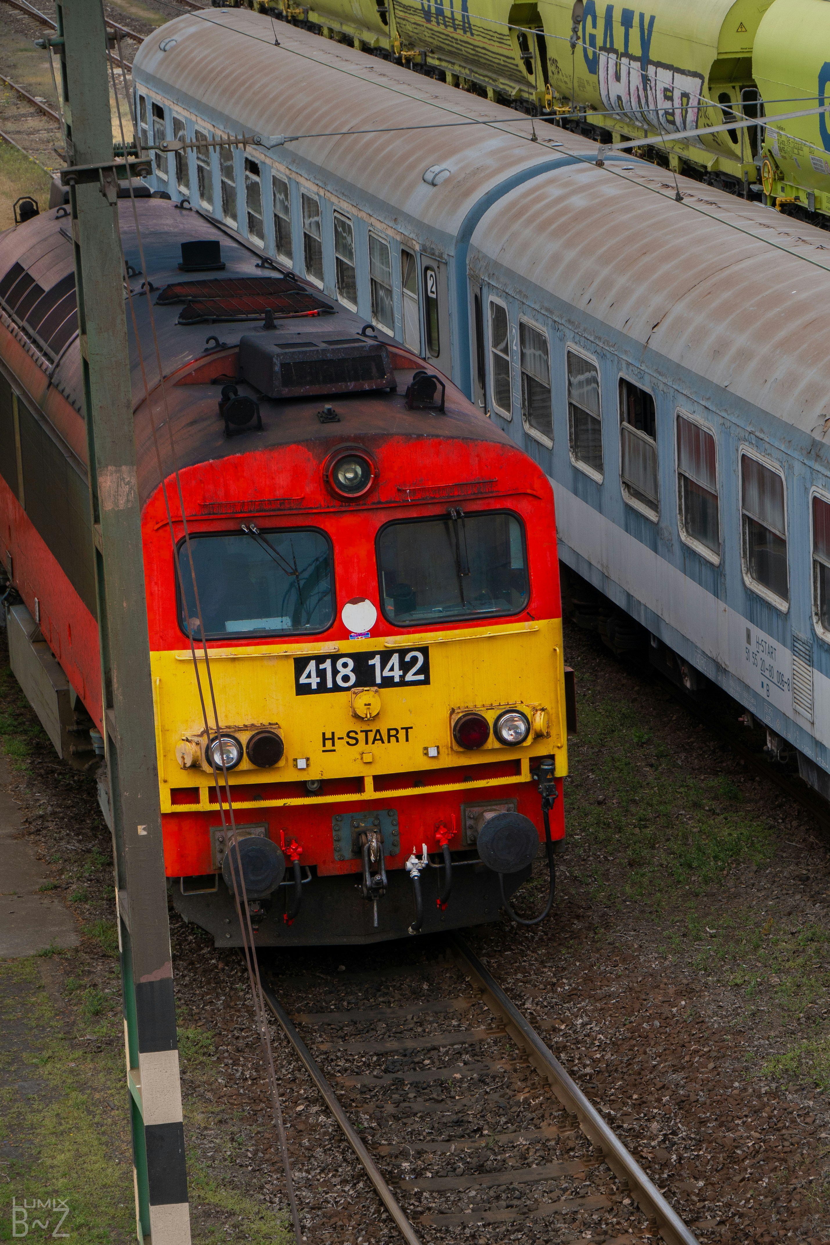 Front-on View of a Bright Red- Yellow Diesel Locomotive on a Rail Yard