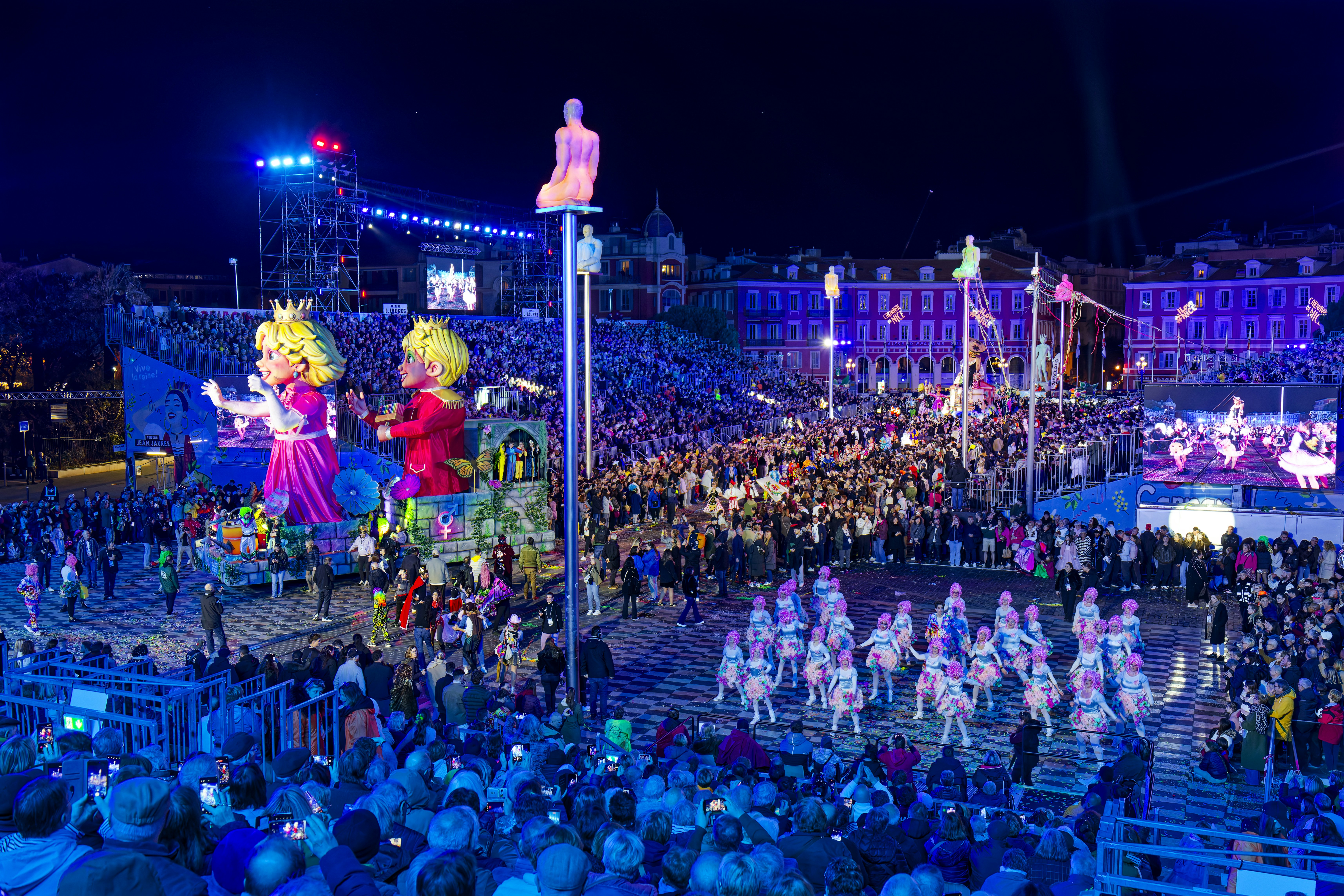 Night Parade of Neon Figures Illuminates a City Square
