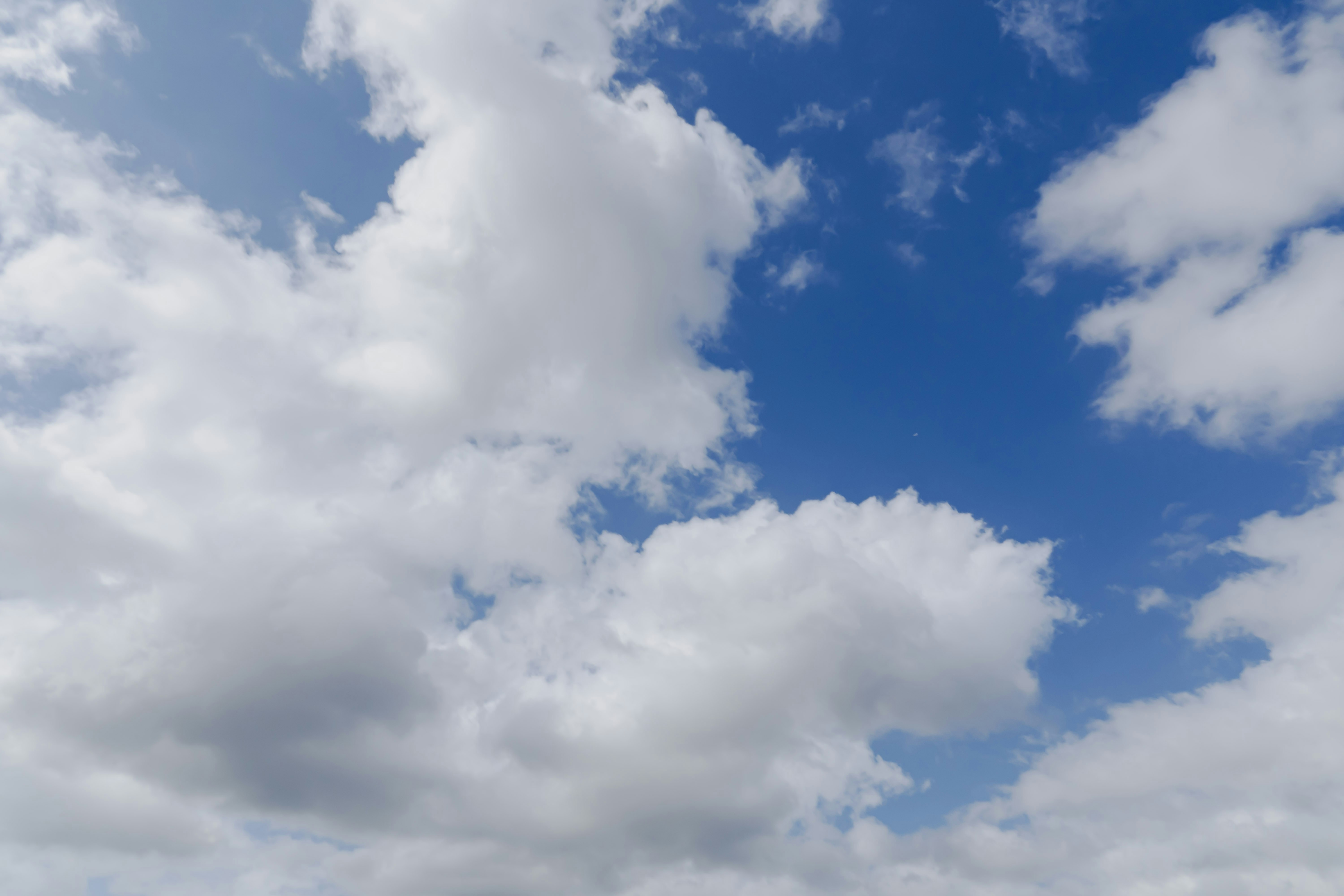 Clear Sky Pulse: A Shot of billowy clouds drifting beneath a vivid blue