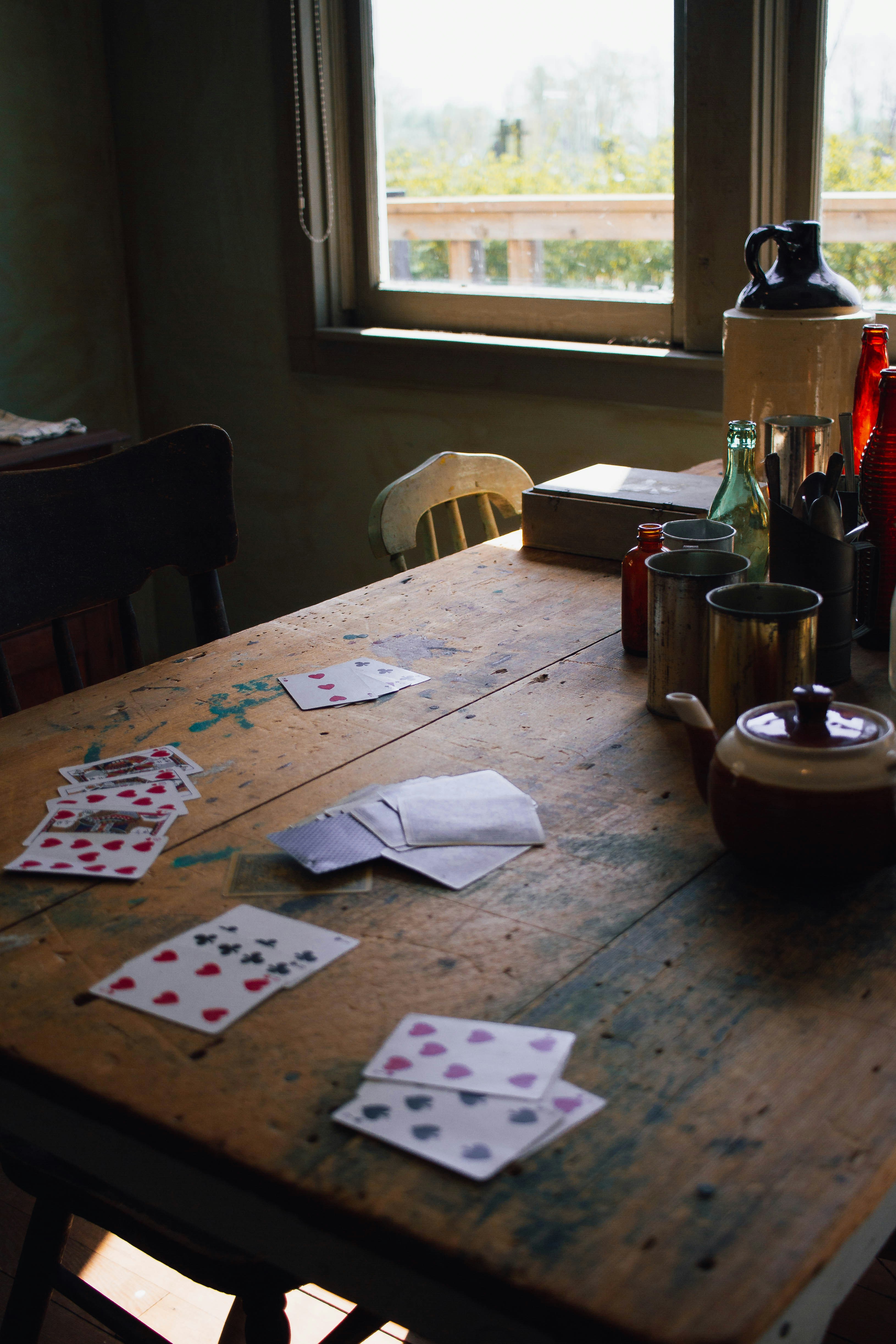Cards on a Weathered Table: Quiet Still Life by the Window