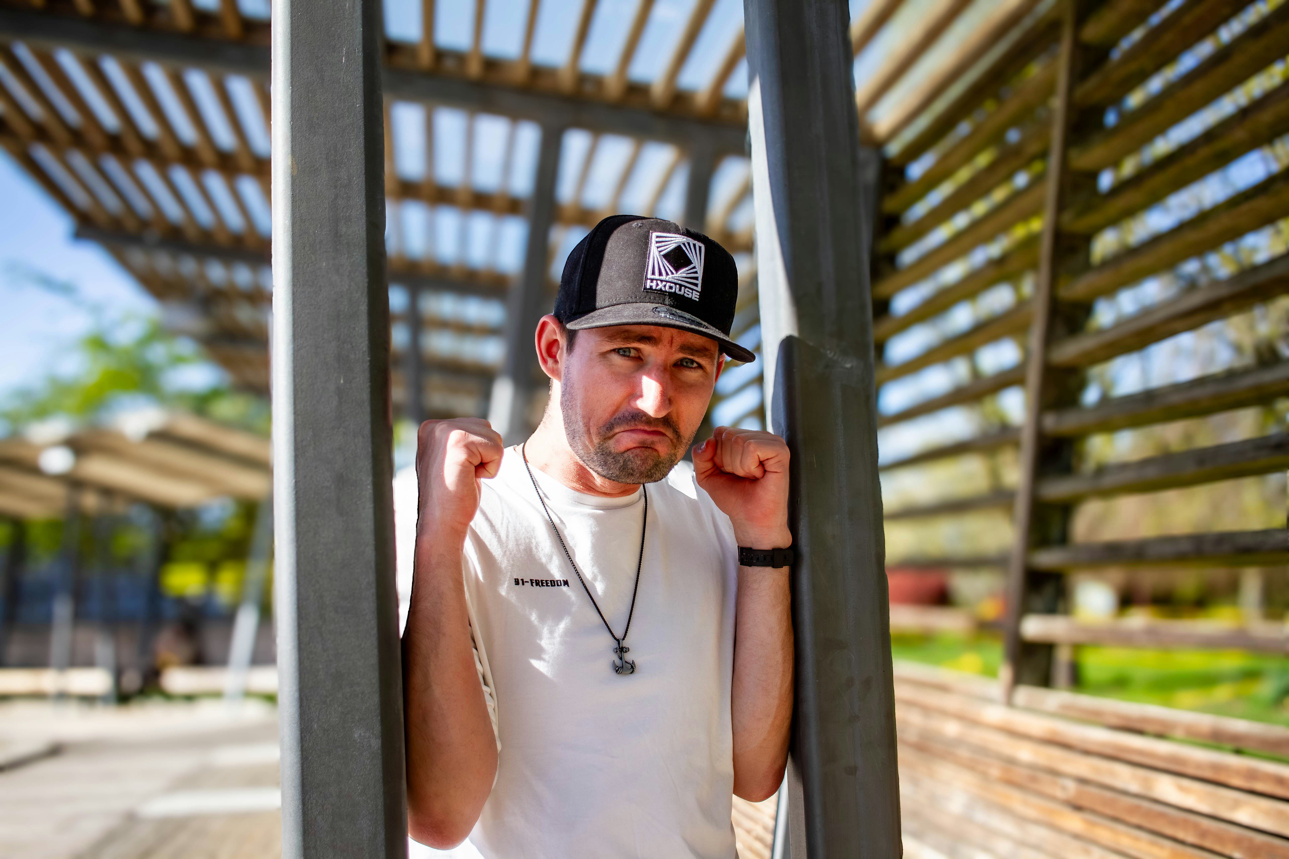 Grip and Grit: A Portrait in a Sunlit Pergola