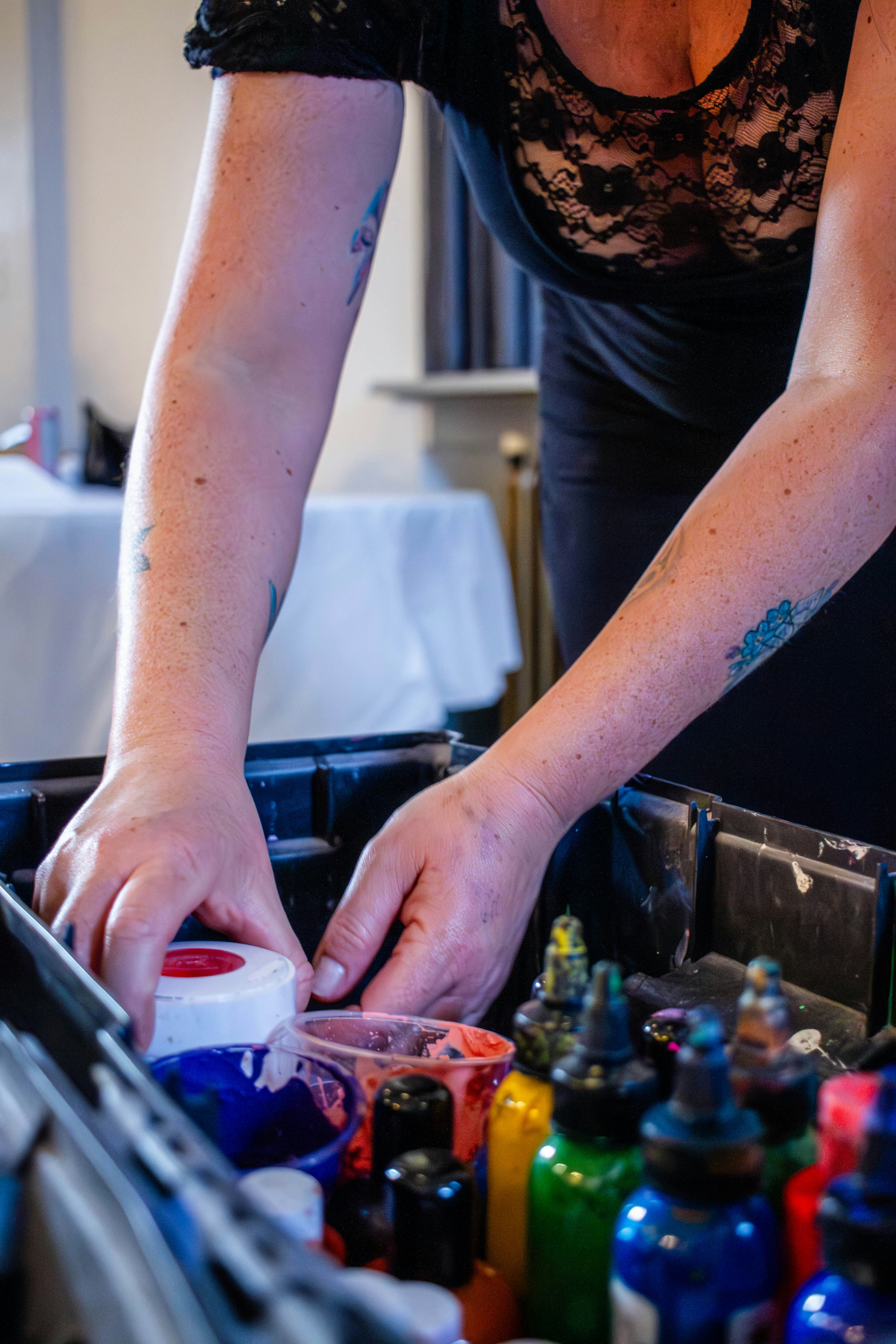 Hands at Work: A Painter’s Pause Over the Palette