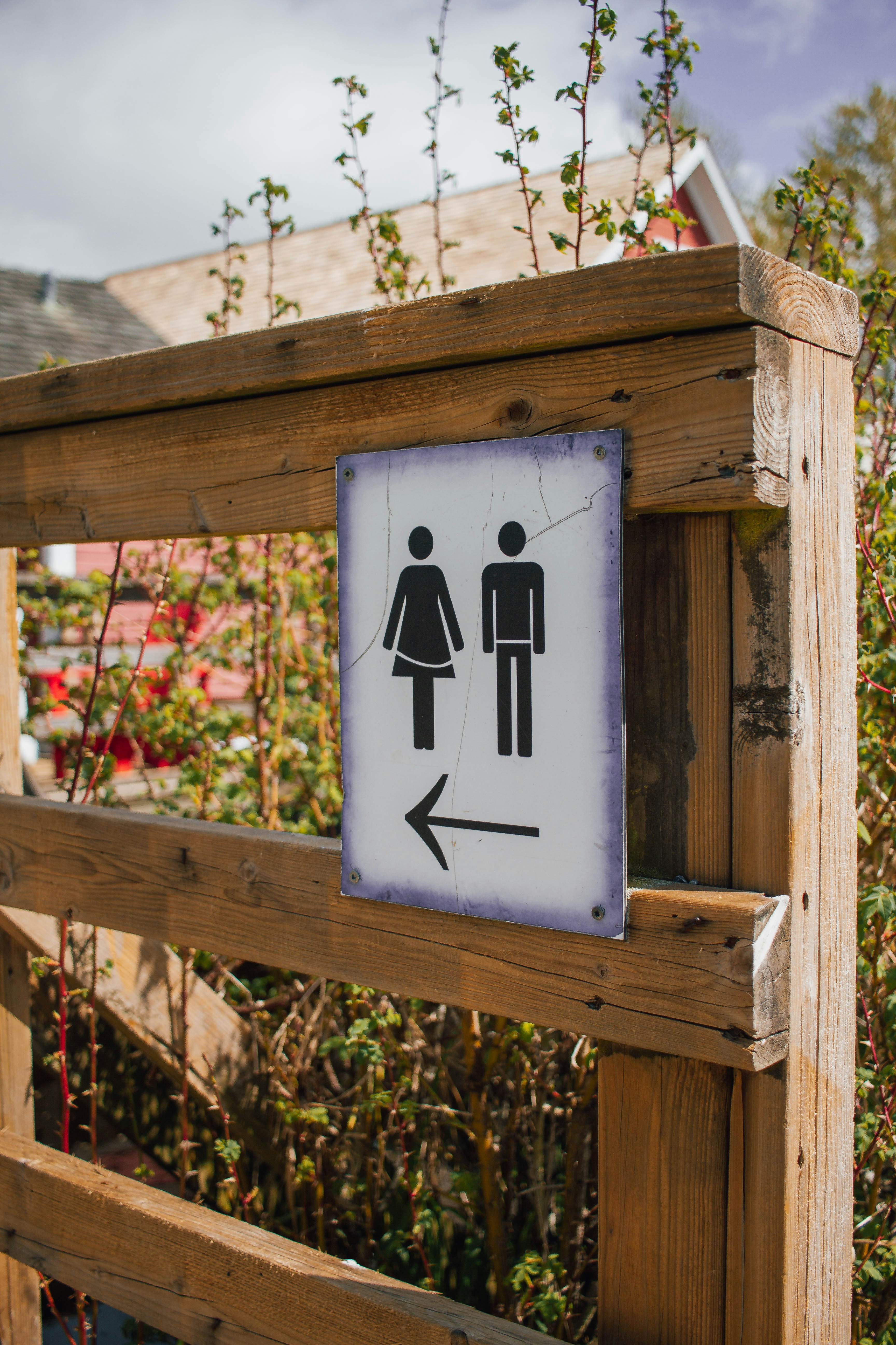 Wooden-frame Pathway Sign Pointing Left to Amenities