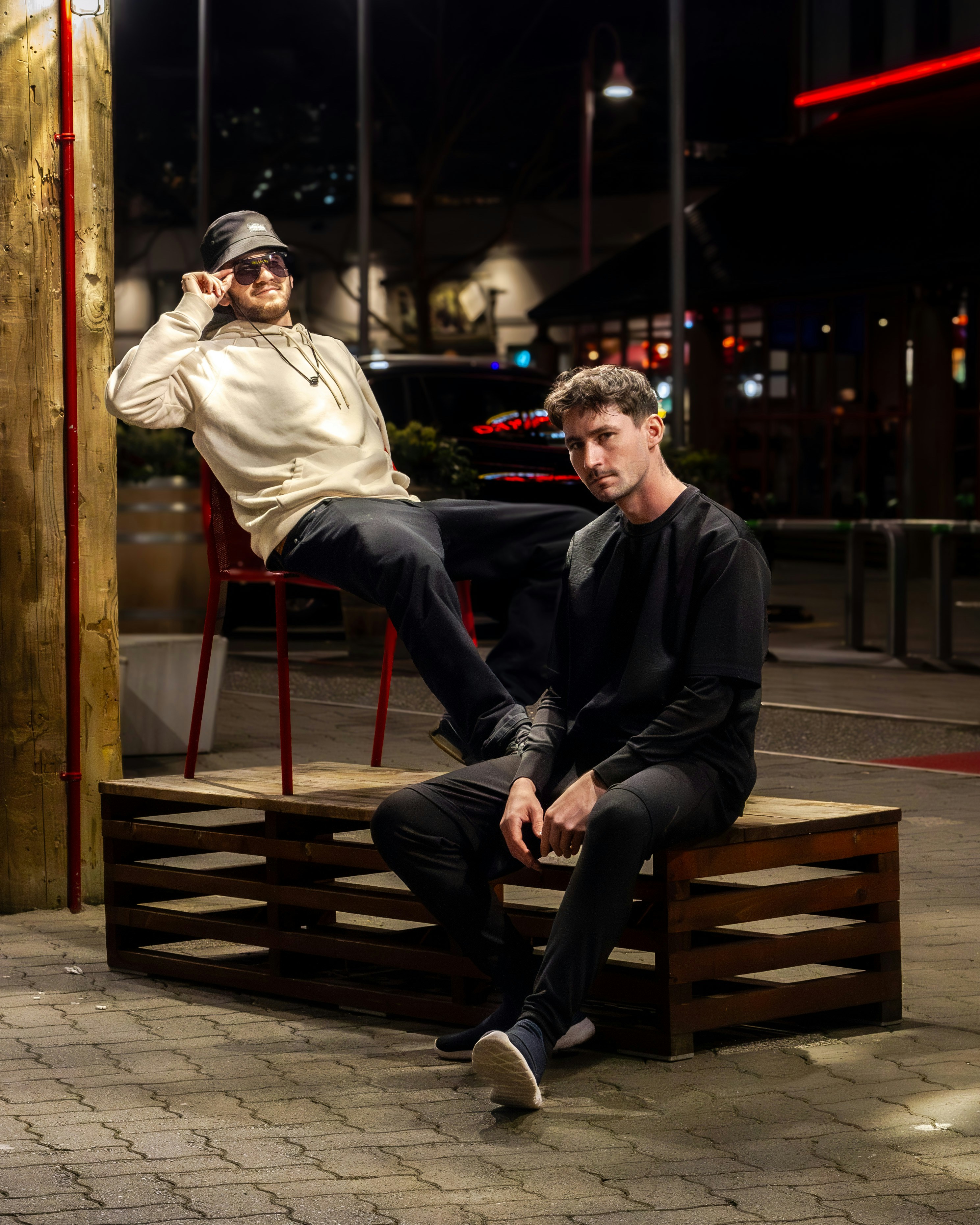 Nightlife Portrait: Two Friends in a Dimly Lit Urban Set