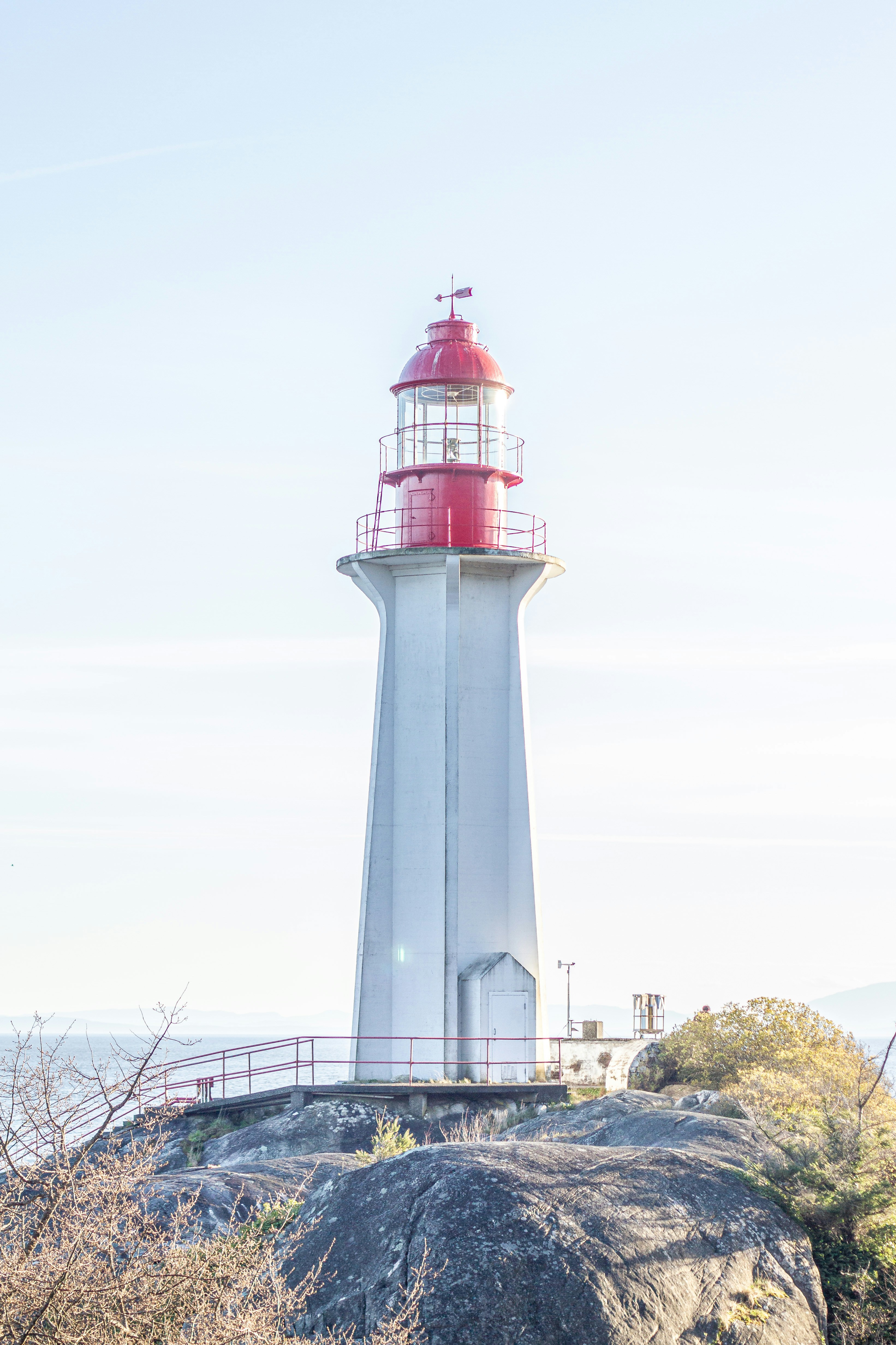 Red Beacon on Granite: A Seaside Lighthouse Reaches for the Sky