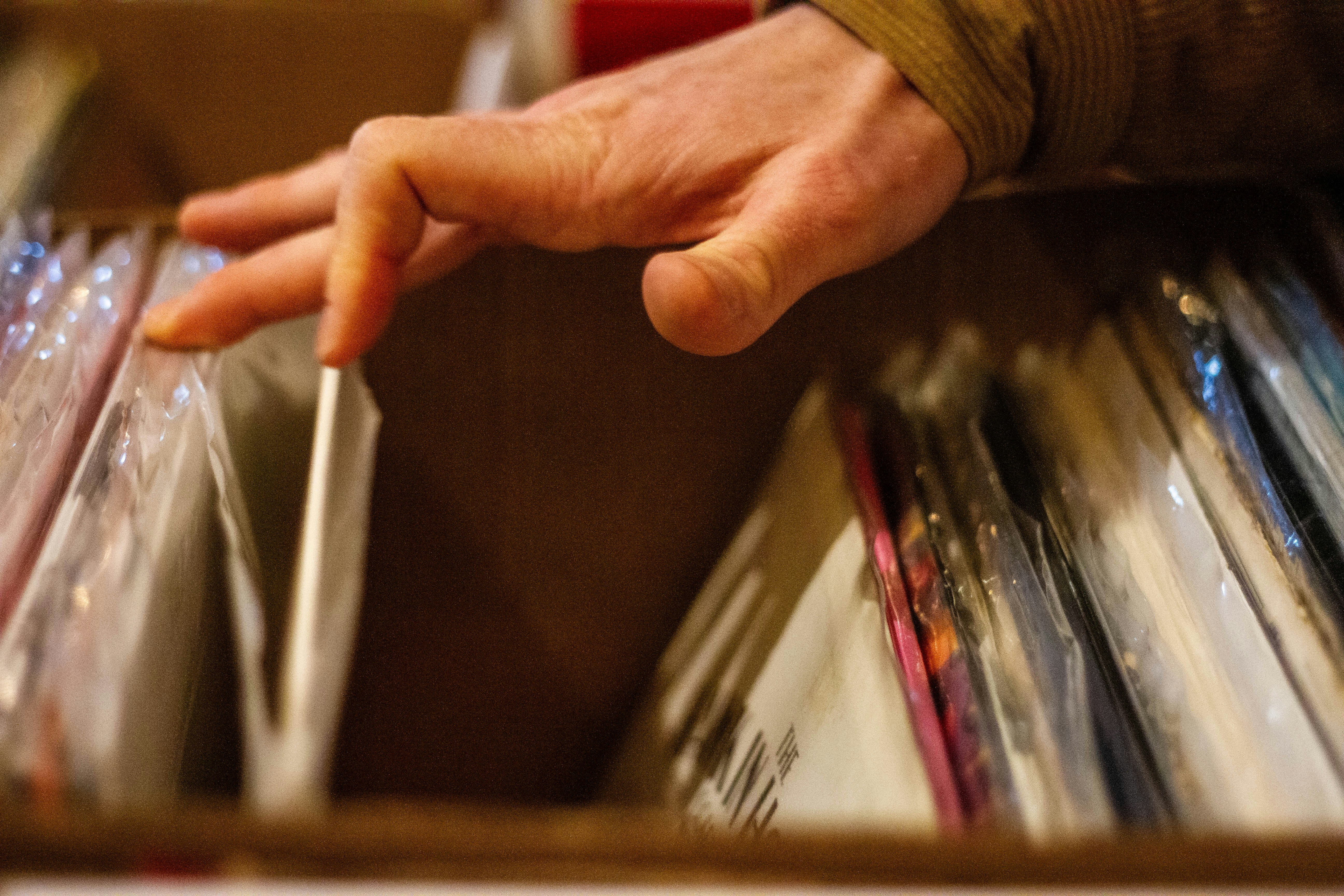 Midnight Cartographer: A Hand Reaches Through a Record Bin
