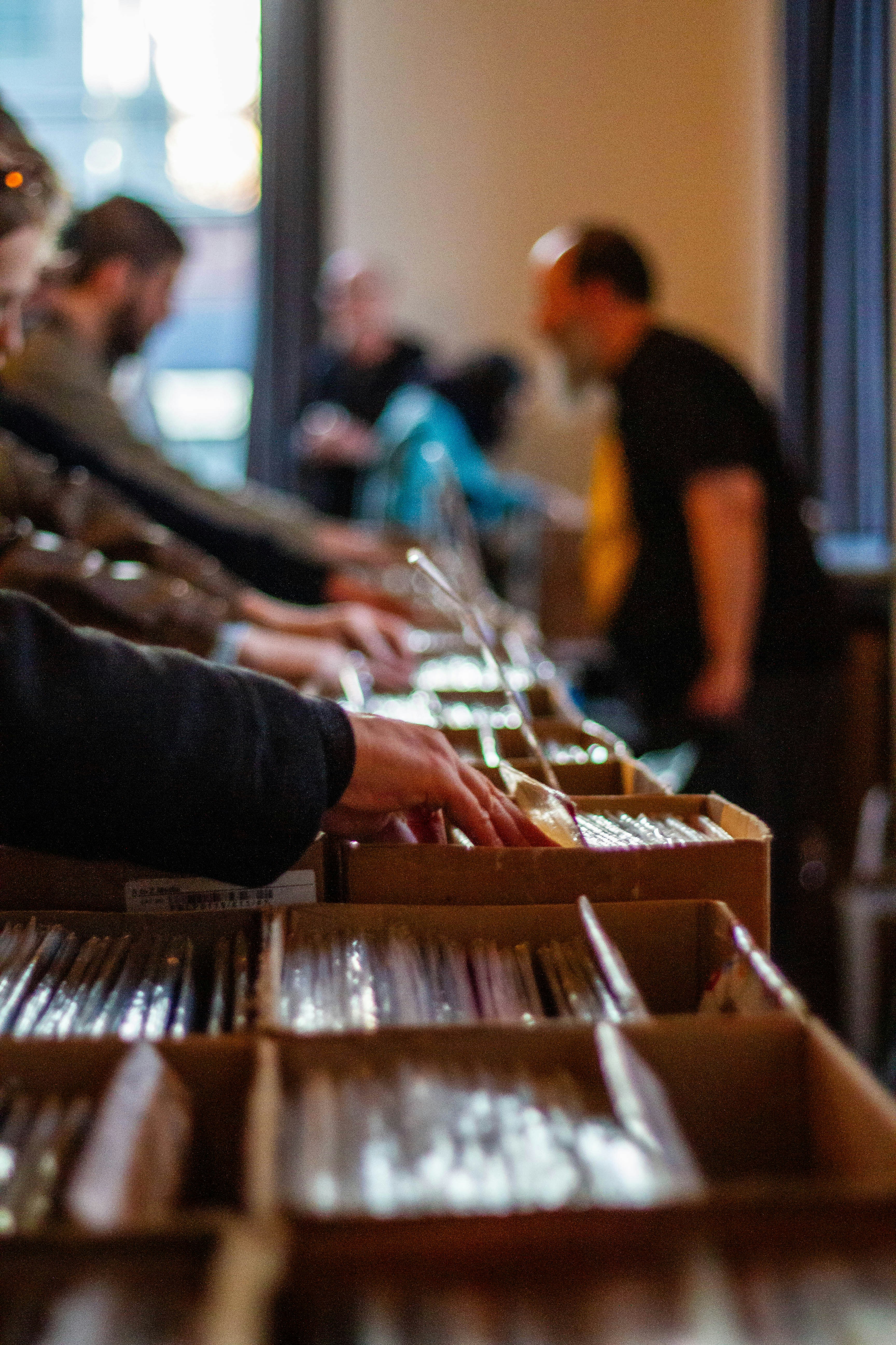 Hands in Sync: A Row of Vinyl Bins in a Busy Market Scene